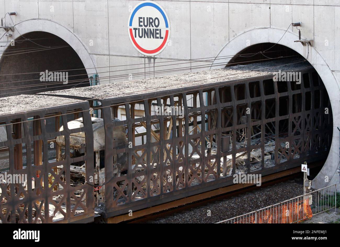 A Eurotunnel freight shuttle train transports the burnt remains of a ...