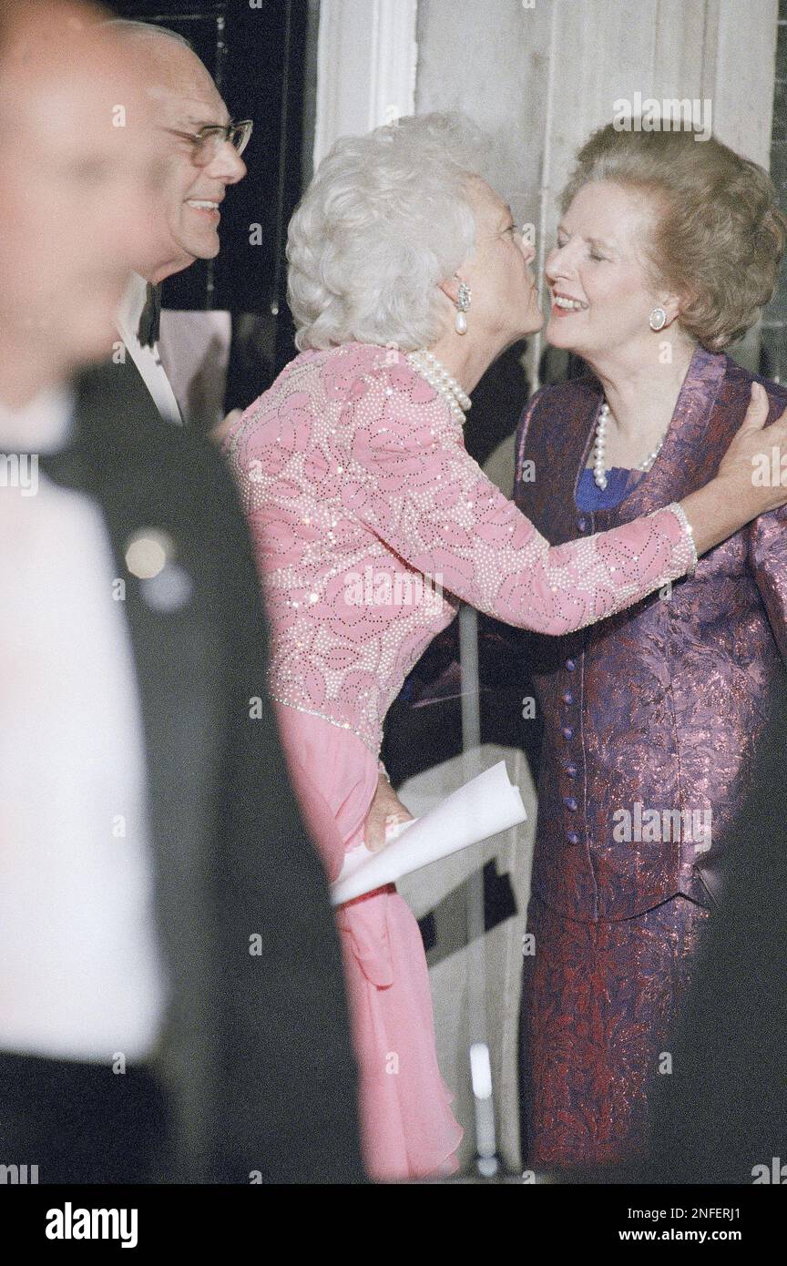 U.S. first lady Barbara Bush, center, kisses British Prime Minister ...