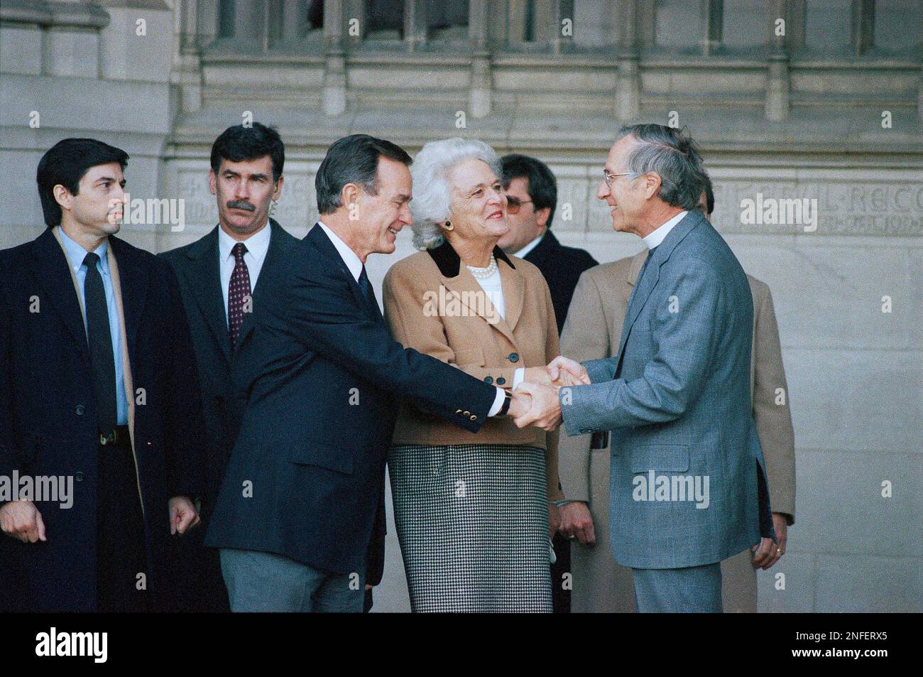 President-elect George Bush and his wife Barbara, shake hands with ...