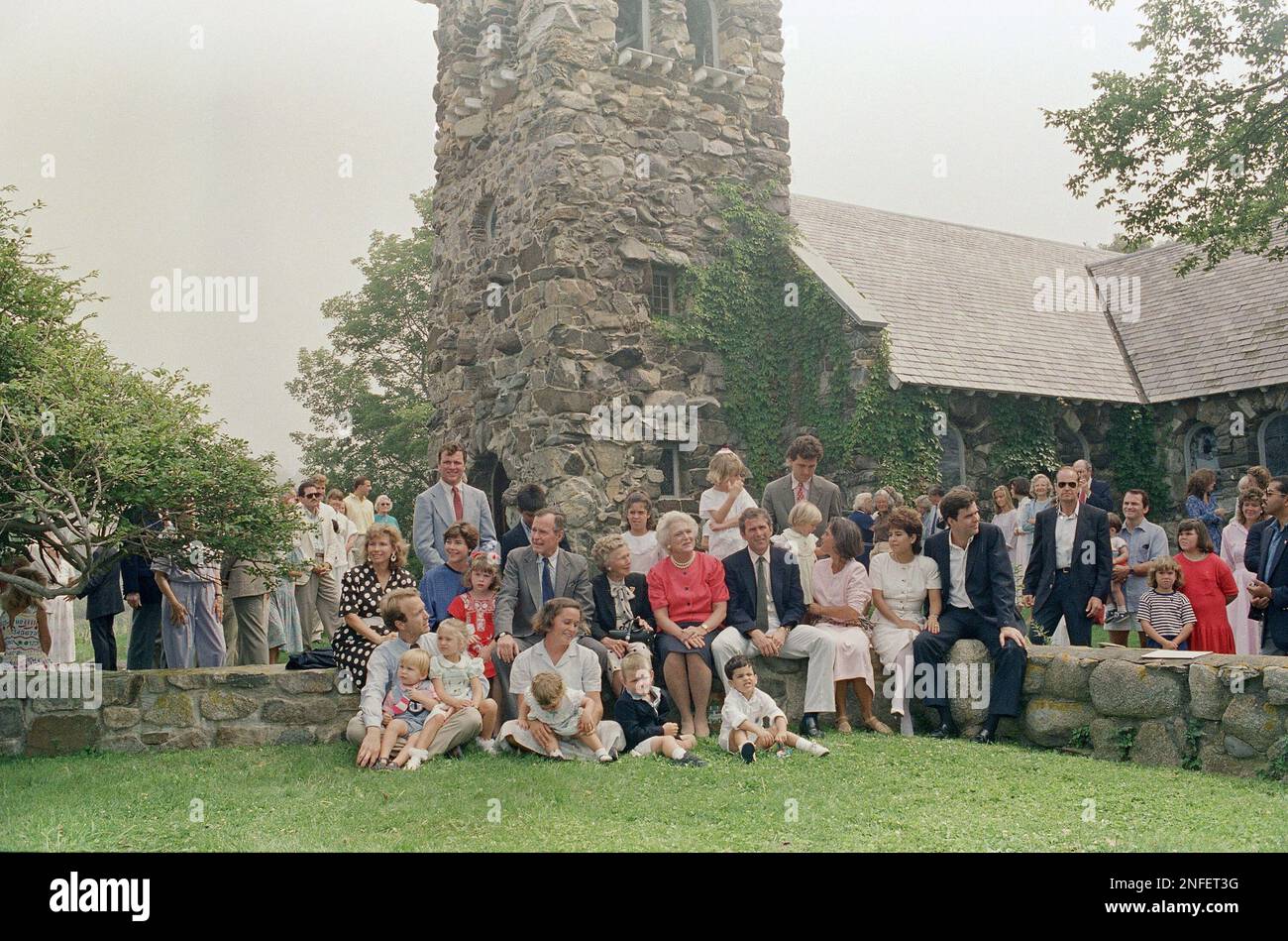 Vice-President George Bush waves while sitting for a family picture ...