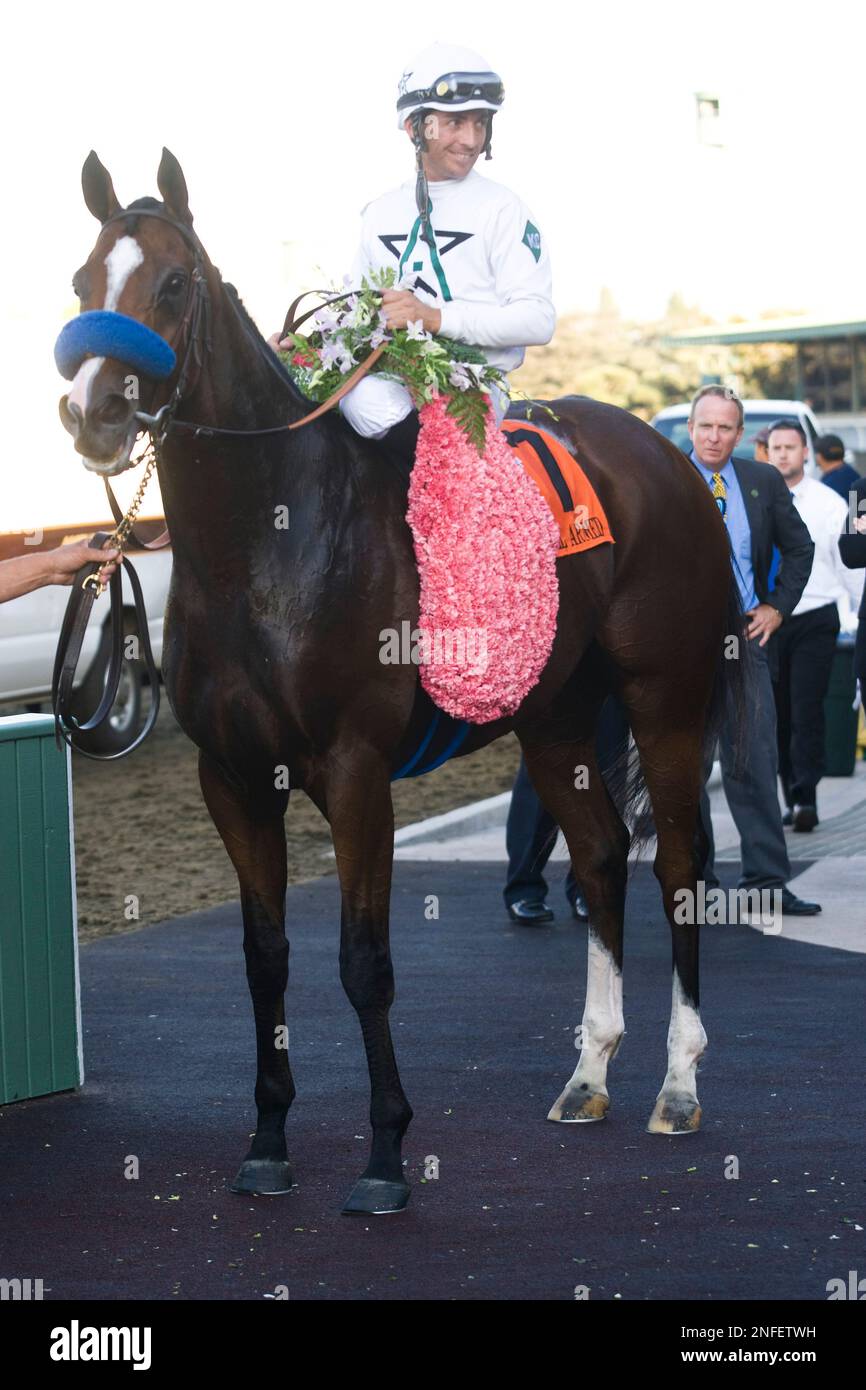 Jockey Aaron Gryder smiles as he rides his horse Well Armed to the ...