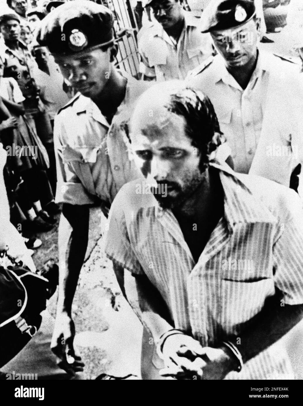 Handcuffed Larry Layton, 32, arrives at Georgetown Magistrate Court for ...