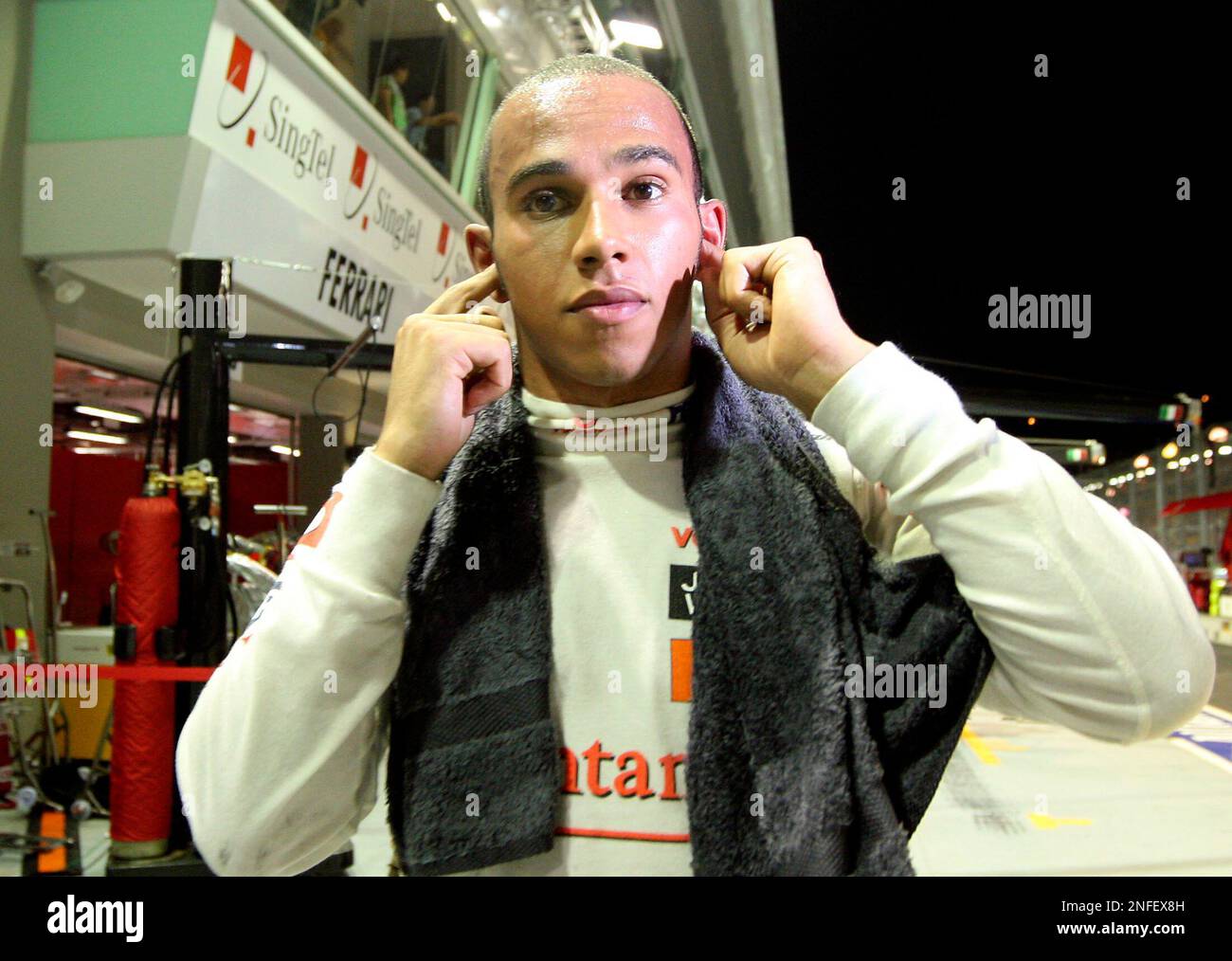 McLaren Mercedes Formula One driver Lewis Hamilton of Britain covers ...