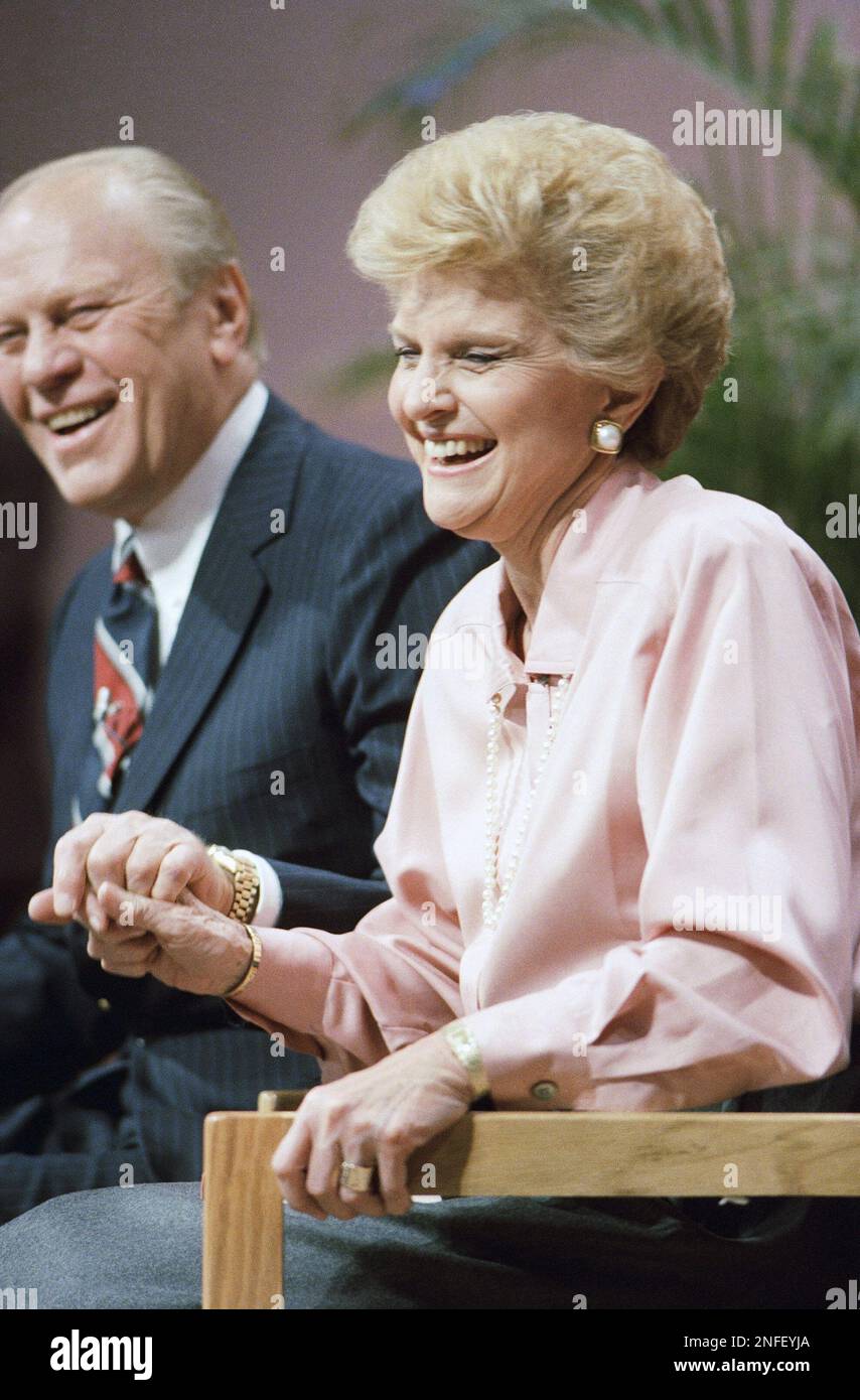Former President Gerald Ford and his wife Betty hold hands as they ...