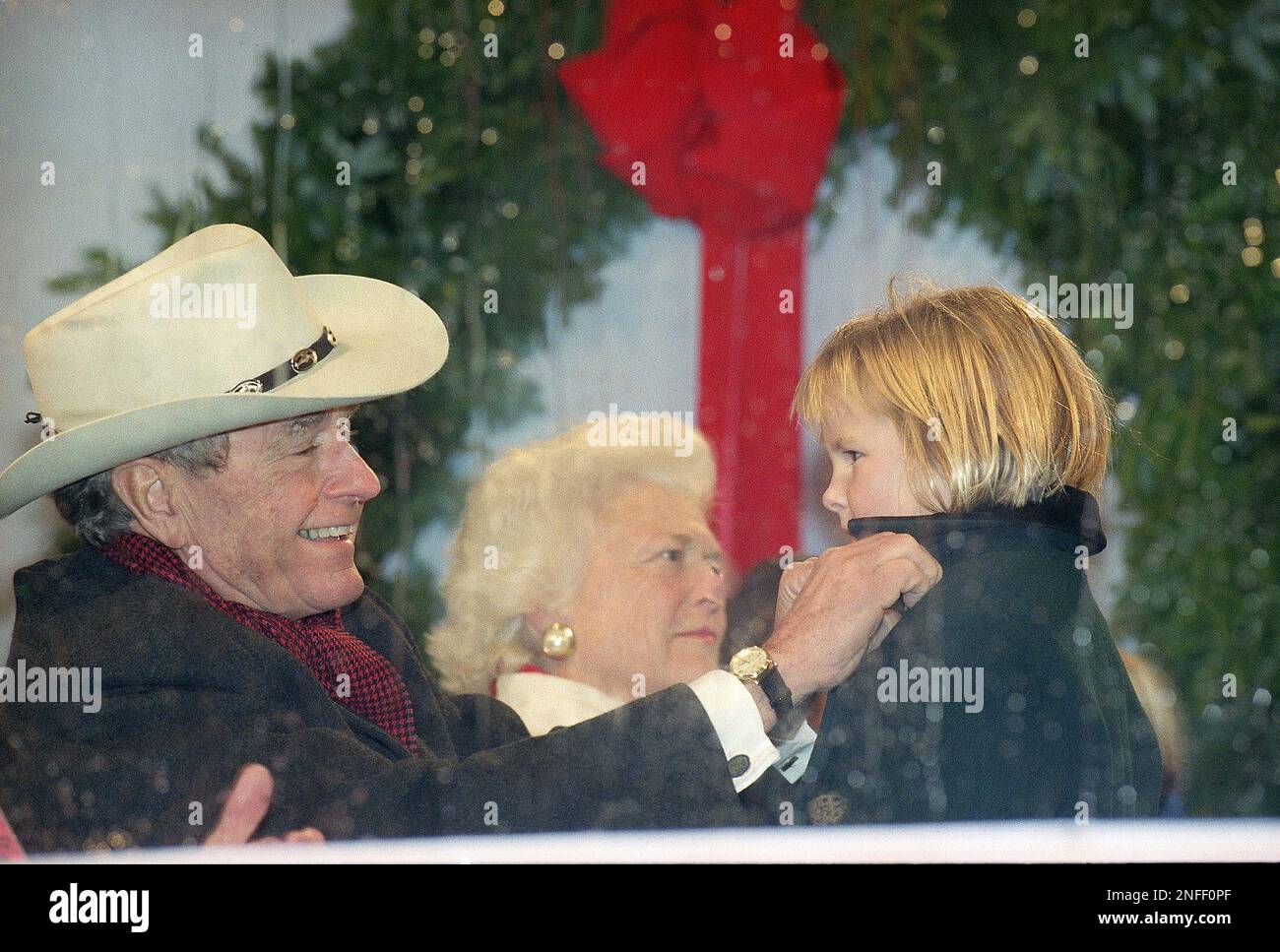 President George Bush secures the coat of his granddaughter Marshall ...
