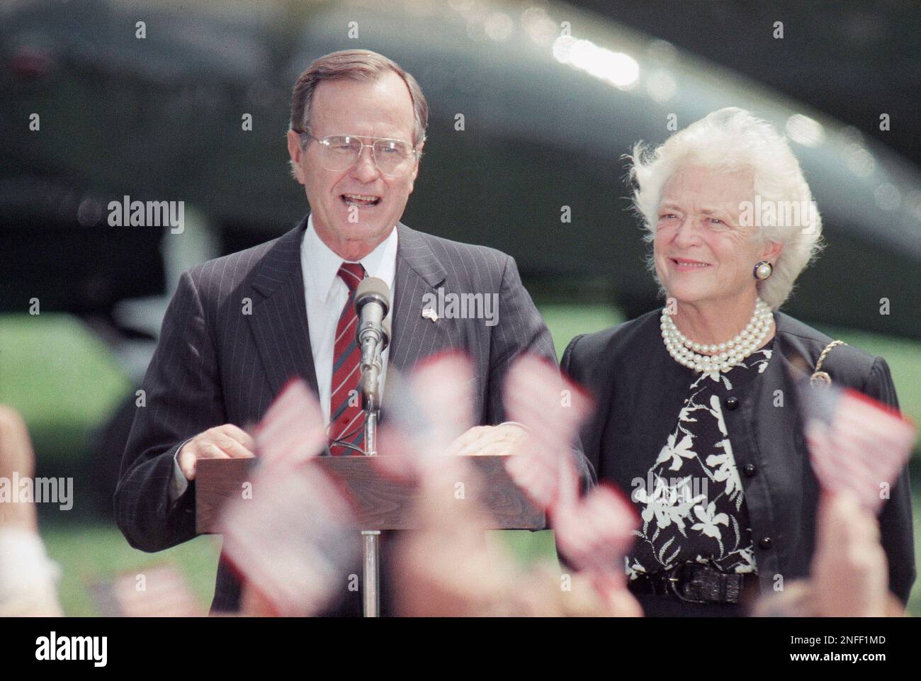 President George H.W. Bush, left, and First Lady Barbara Bush smile as ...