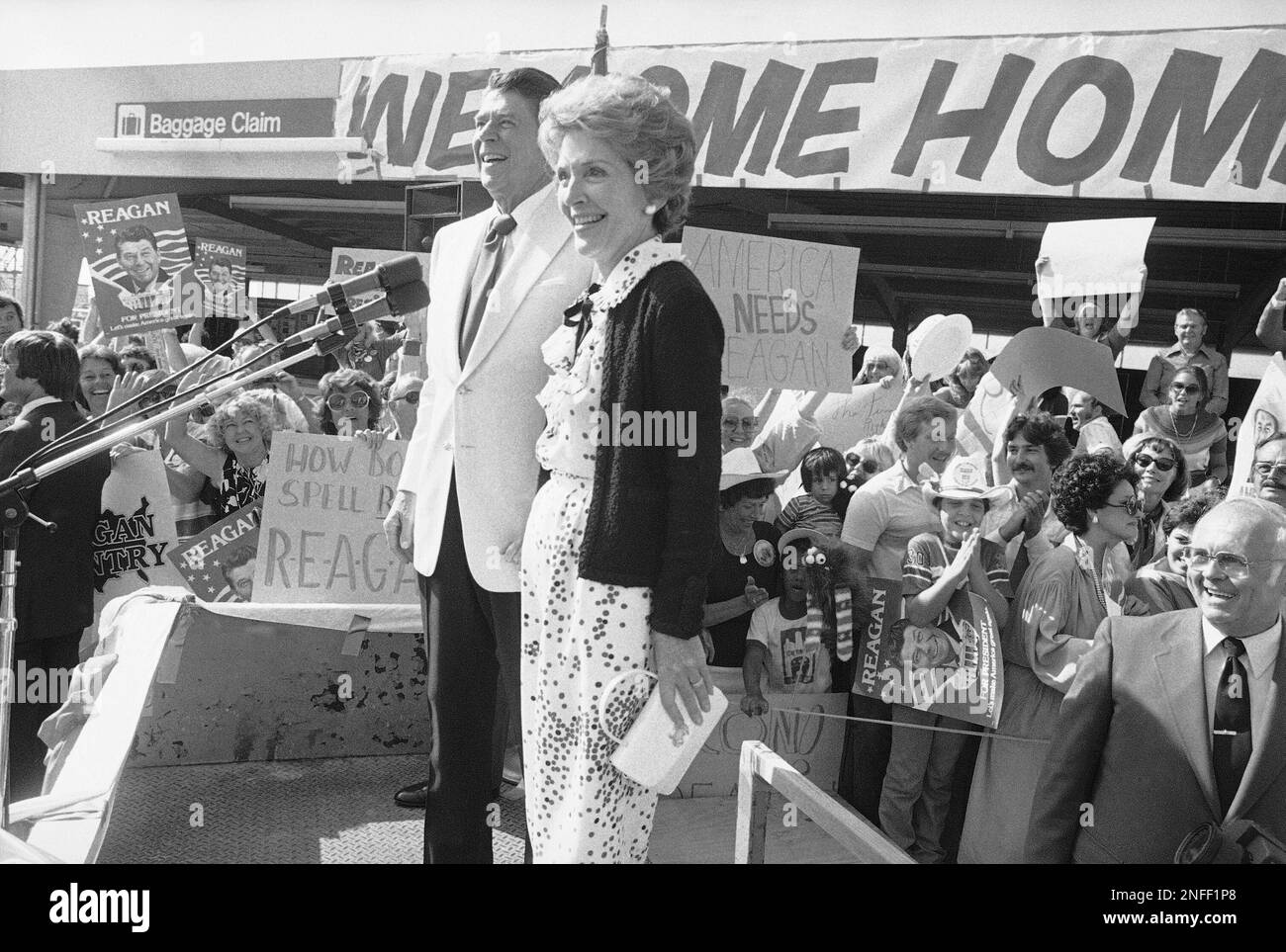 Ronald Reagan and his wife Nancy smile before addressing an estimated ...