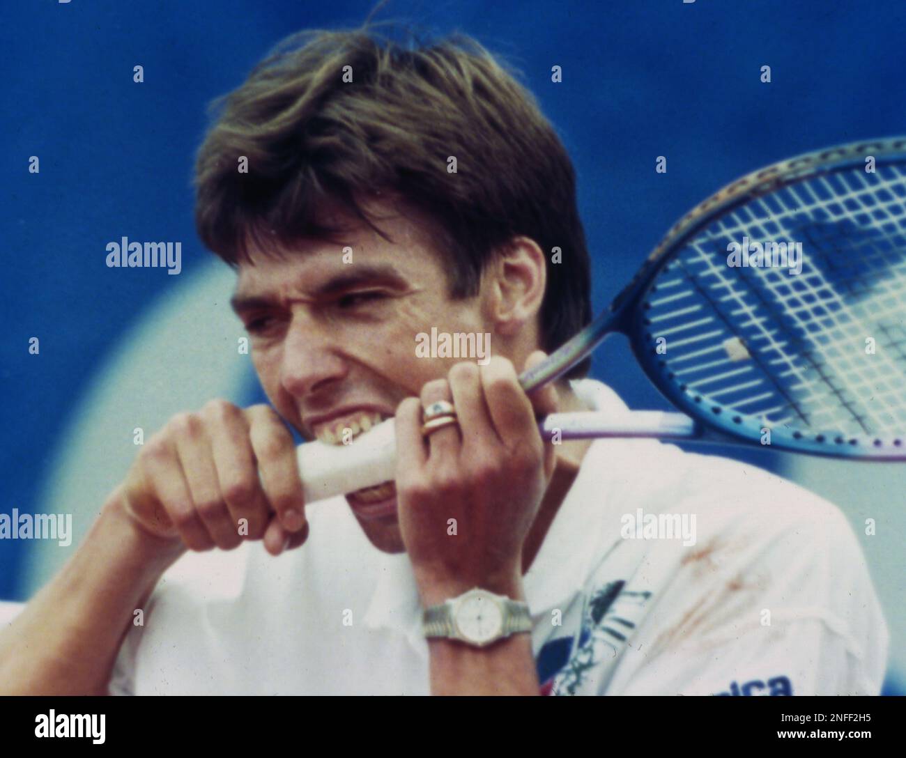 German tennis player Michael Stich bites the handle of his racket ...
