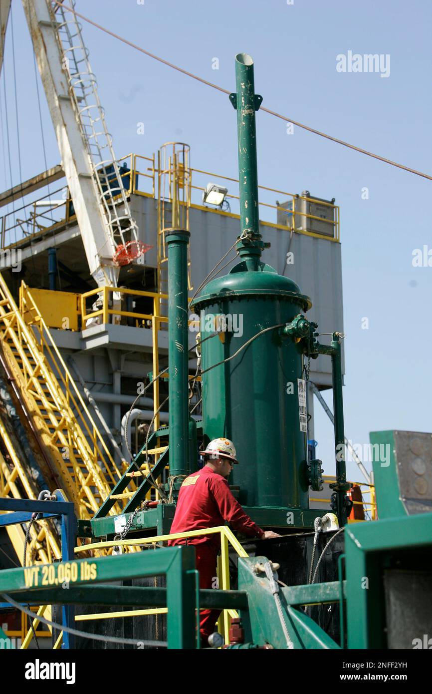 An oil rig crew worker is photographed on the Chevron Genesis Oil Rig ...