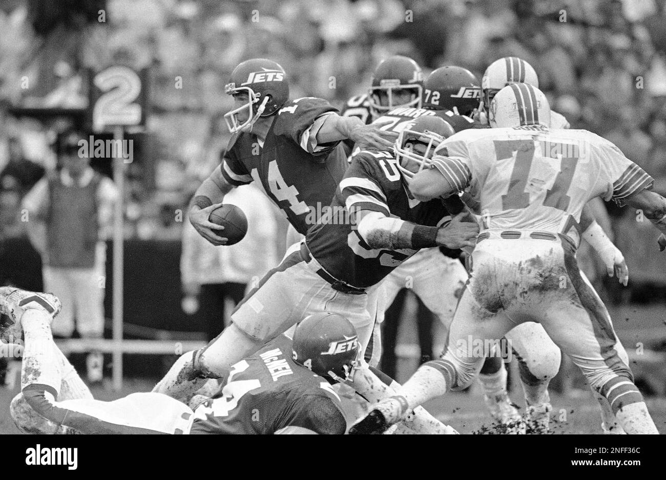 New York Jets quarterback Richard Todd (14) moves past players and ...