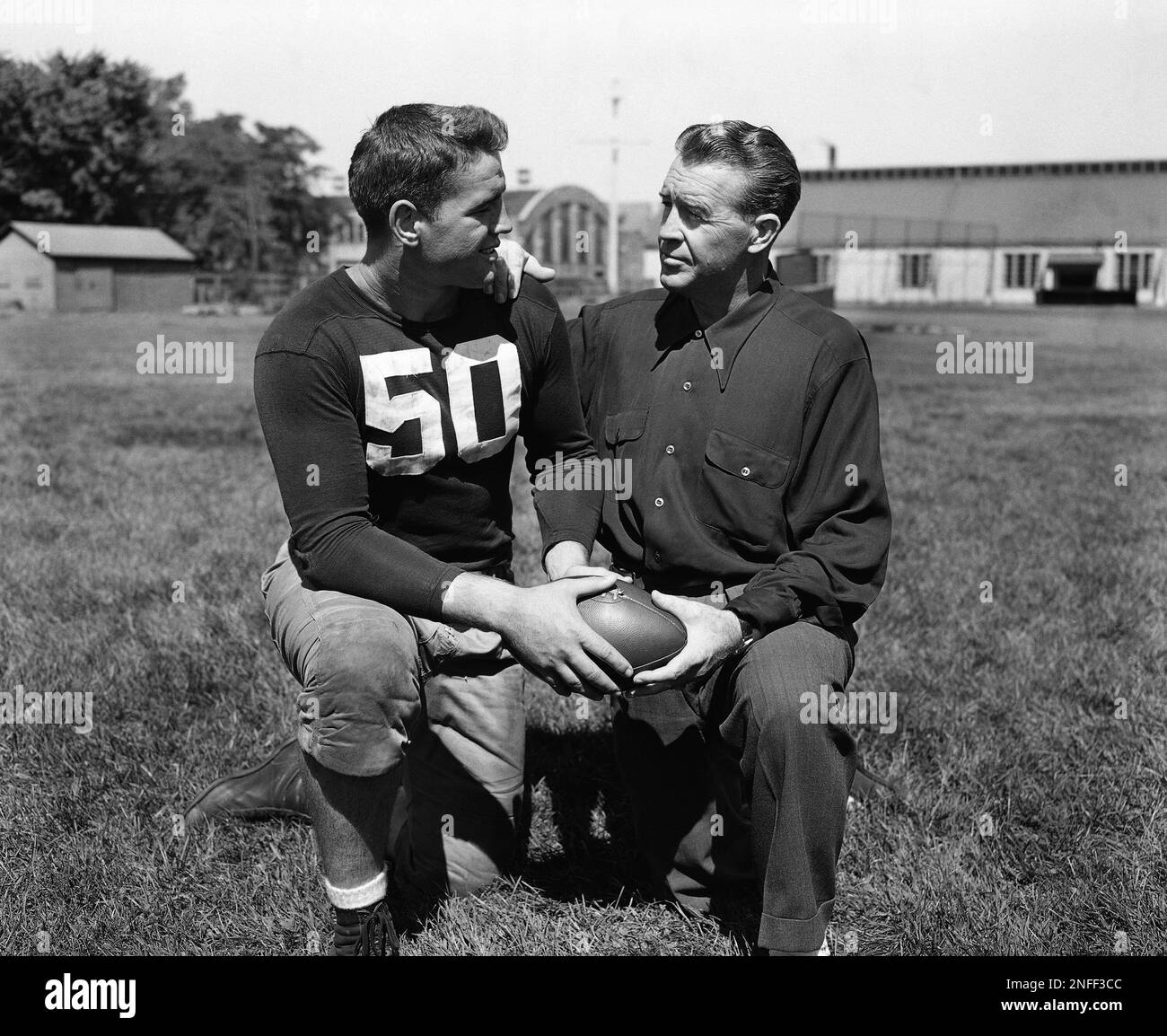 Notre Dame's football captain Jerry Groom (50) and coach Frank Leahy ...