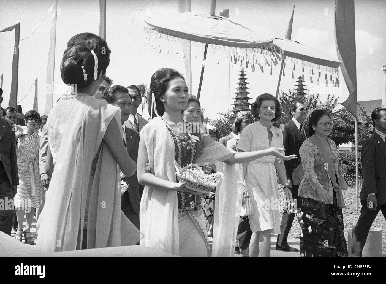 First Lady Betty Ford, center, is shaded by oriental umbrellas as she ...