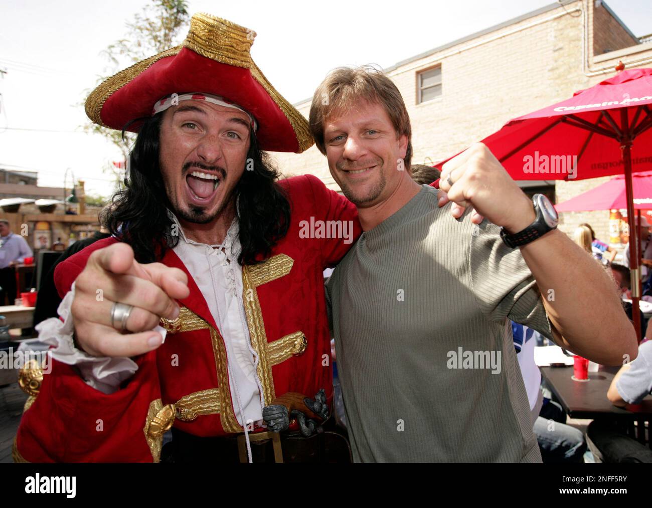 Captain Morgan poses with former Chicago Cub Mickey Morandini during ...