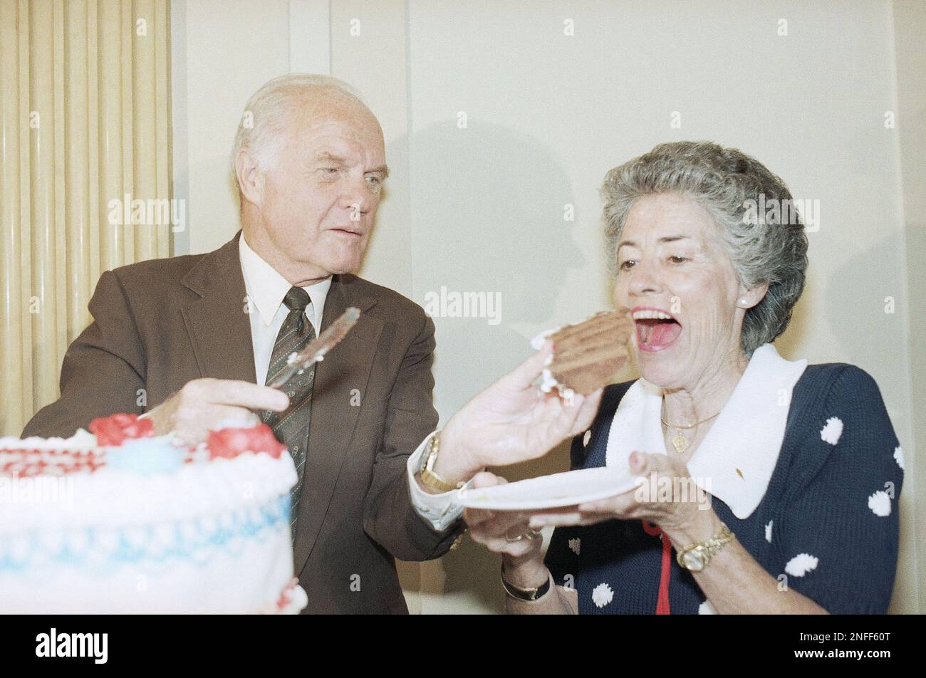 Sen. John Glenn, D-Ohio, left, gives a piece of birthday cake to his ...