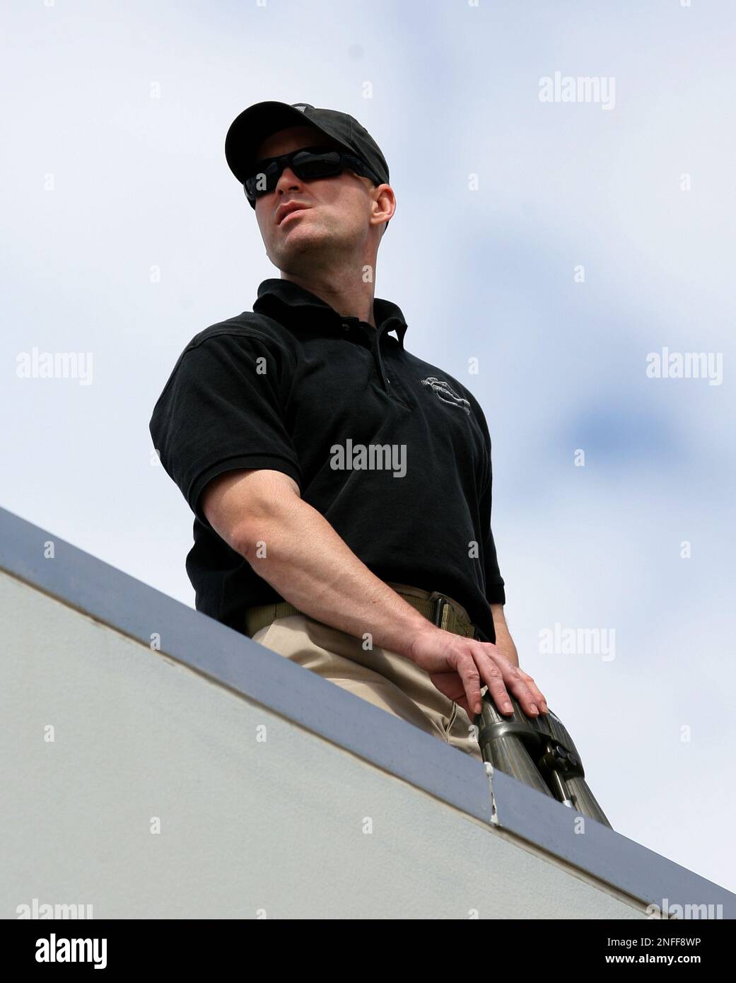 A U.S. Secret Service agent watches from the top of the U.S. Coast ...