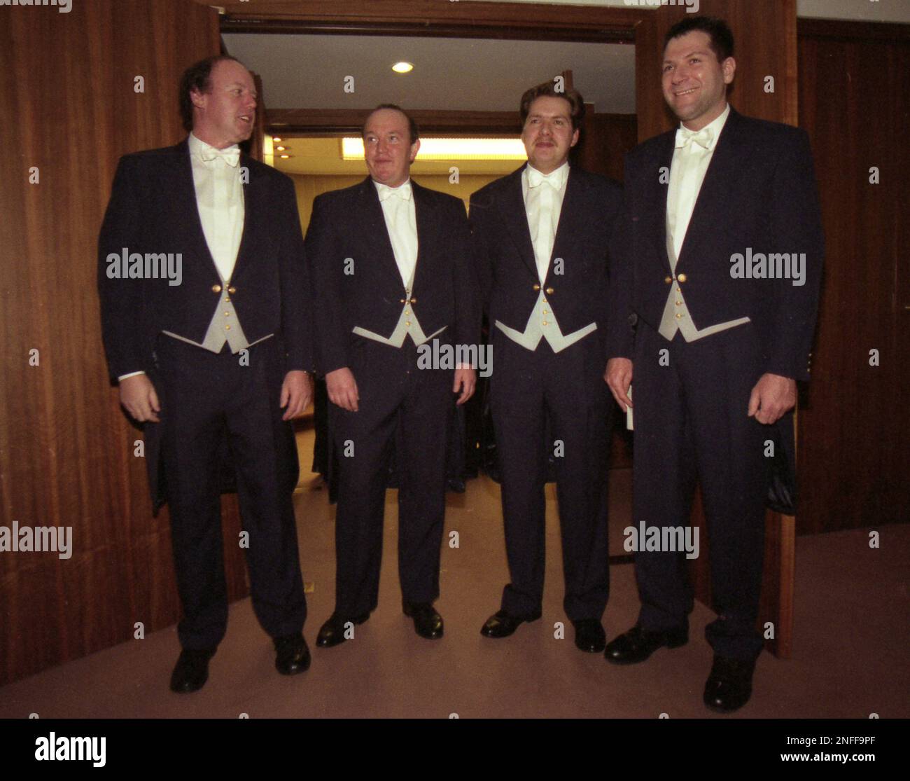 Four ushers serving the German government pose in front of a meeting ...