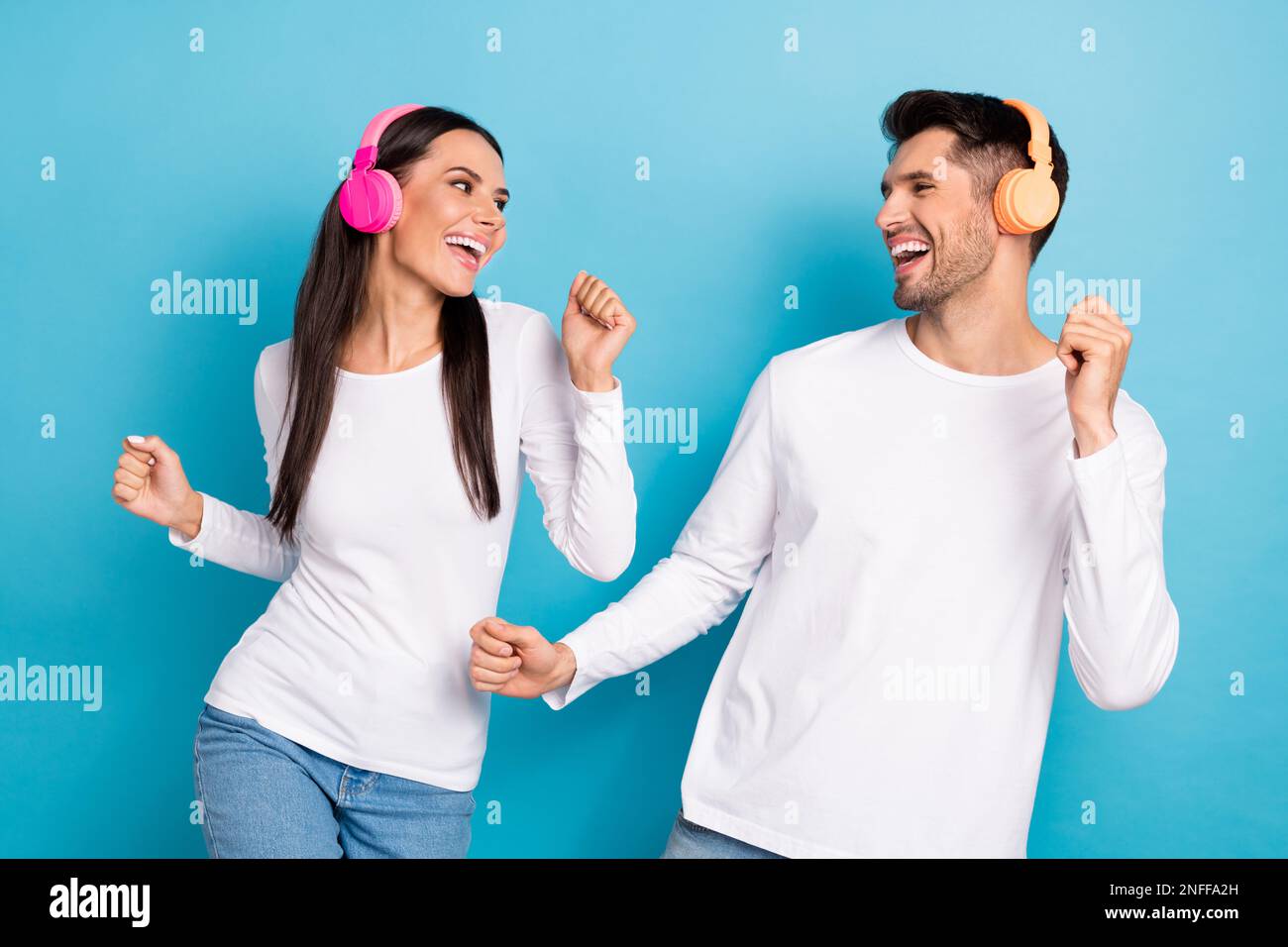 Portrait of two overjoyed positive partners listen music dancing have ...