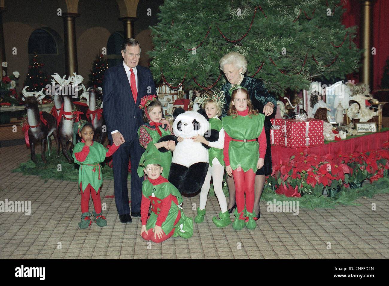 President George Bush and Mrs. Barbara Bush pose with some of their ...