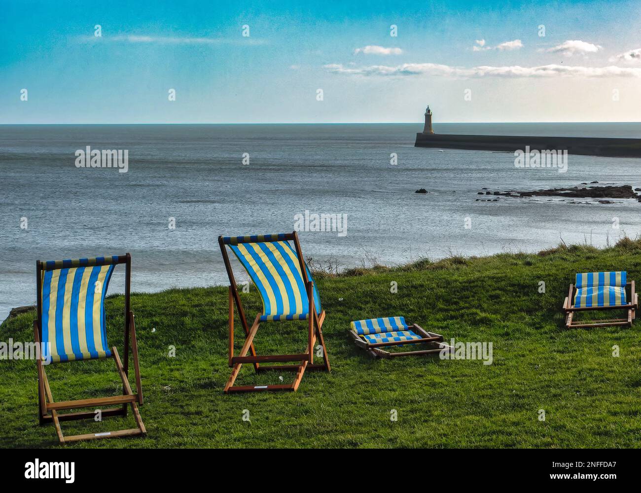 Deck chairs blowing in the wind Stock Photo - Alamy