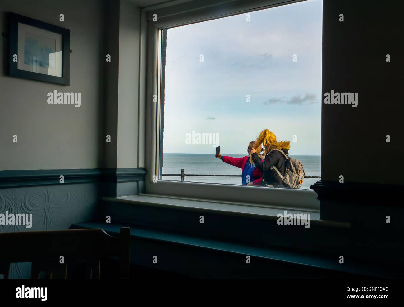 Taking a selfie in front of the window Stock Photo - Alamy