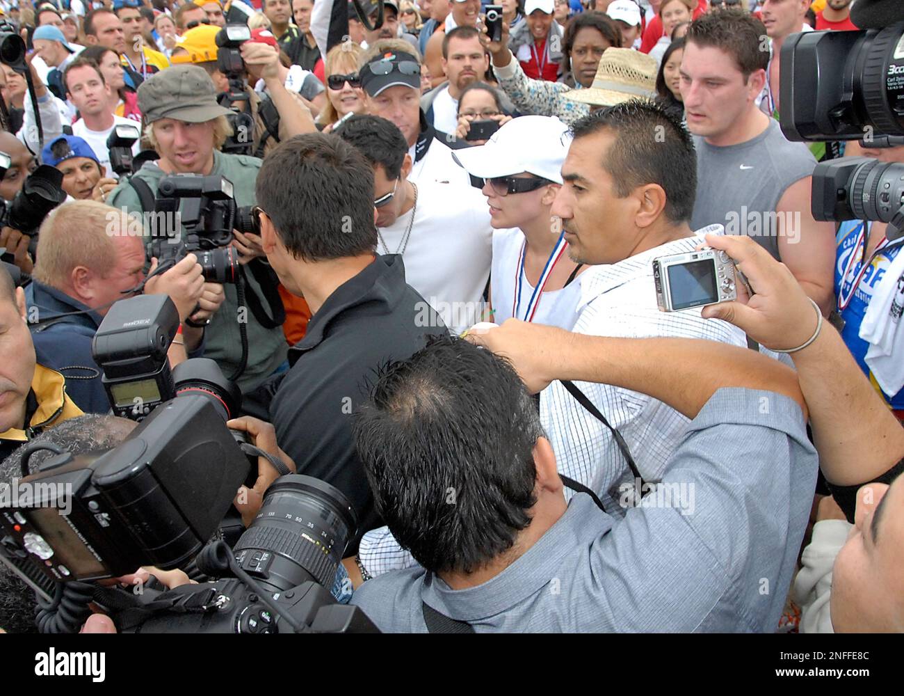 Actress Jennifer Lopez, center with white hat, with her husband, singer ...