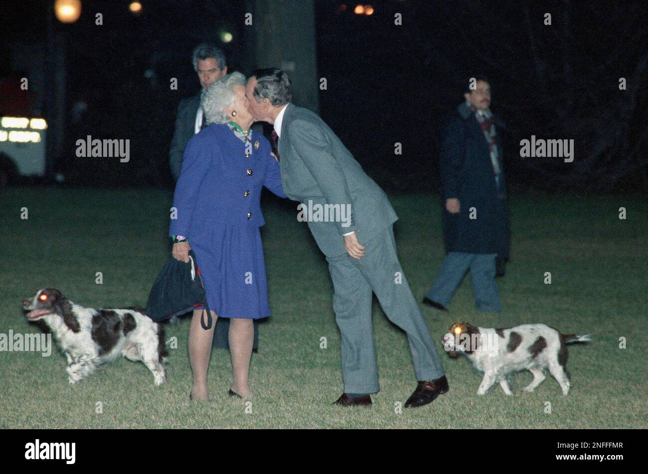 U.S. President George Bush gets a kiss from his wife Barbara Bush as ...
