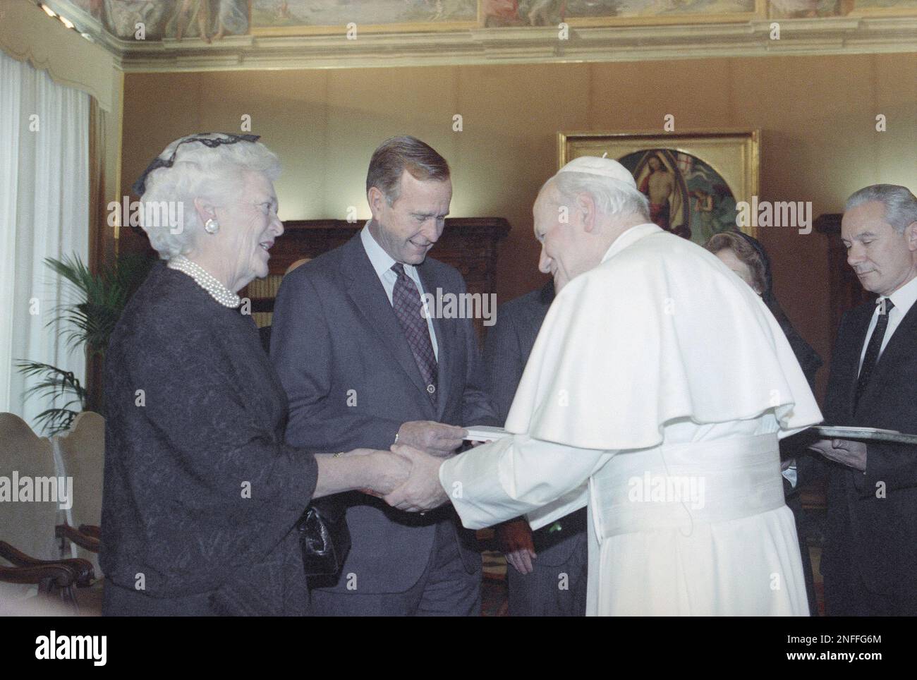 Pope John Paul II holds Mrs. Barbara Bush's hand while the Pope and U.S ...