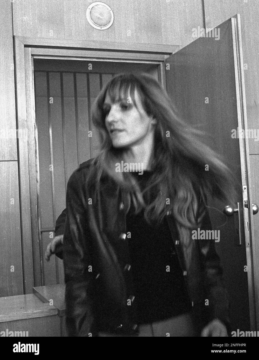 With swaying hair Gudrun Ensslin enters the court room by two security ...