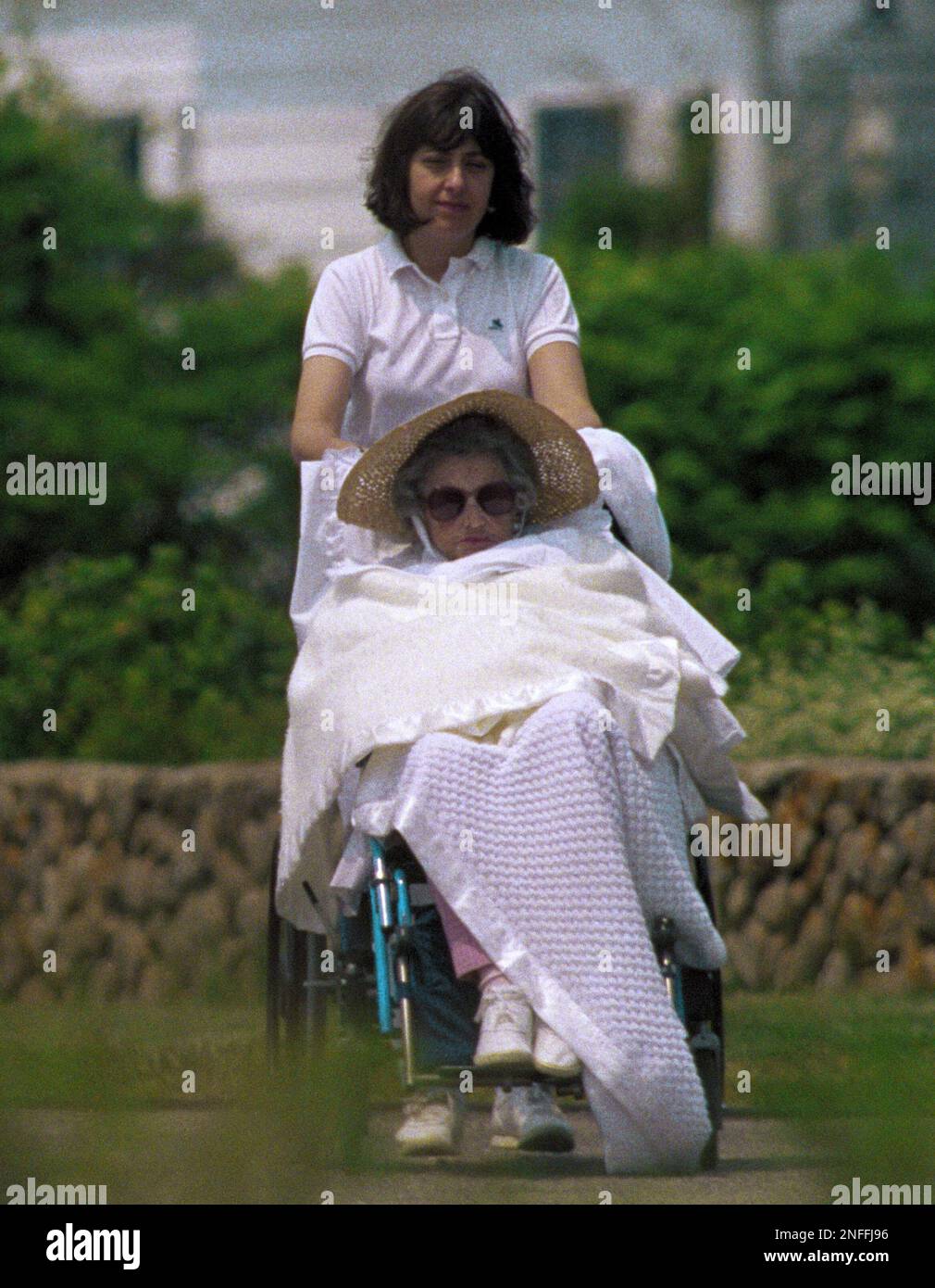 Rose Kennedy, age 100, takes her daily stroll with her nurse, around ...