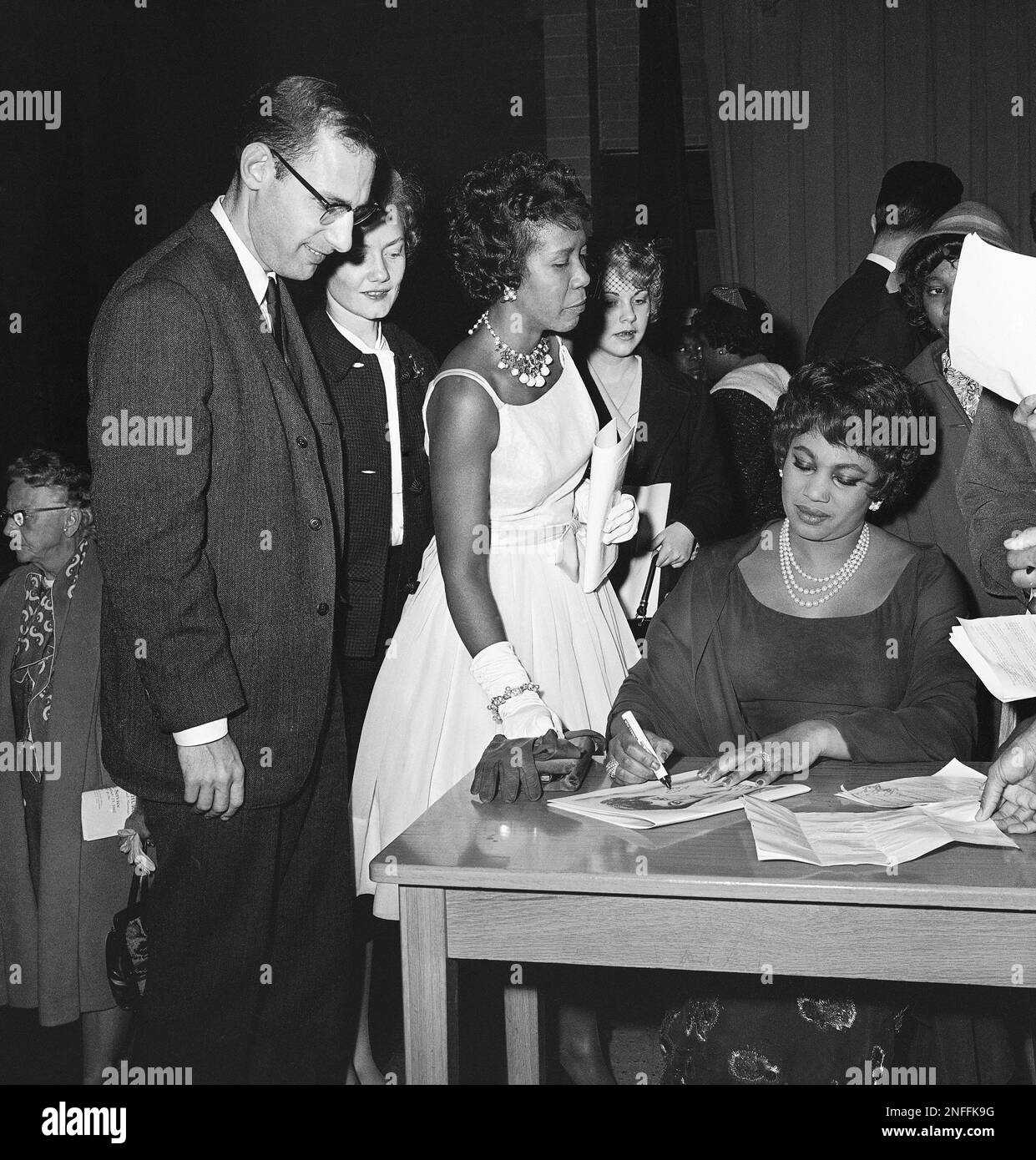 Opera Singer Leontyne Price, right, signing autographs for fans who ...