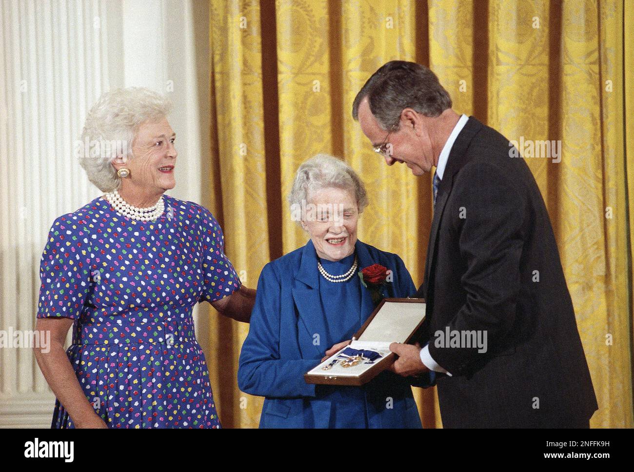 U.S. President George Bush and first lady Barbara Bush present the ...