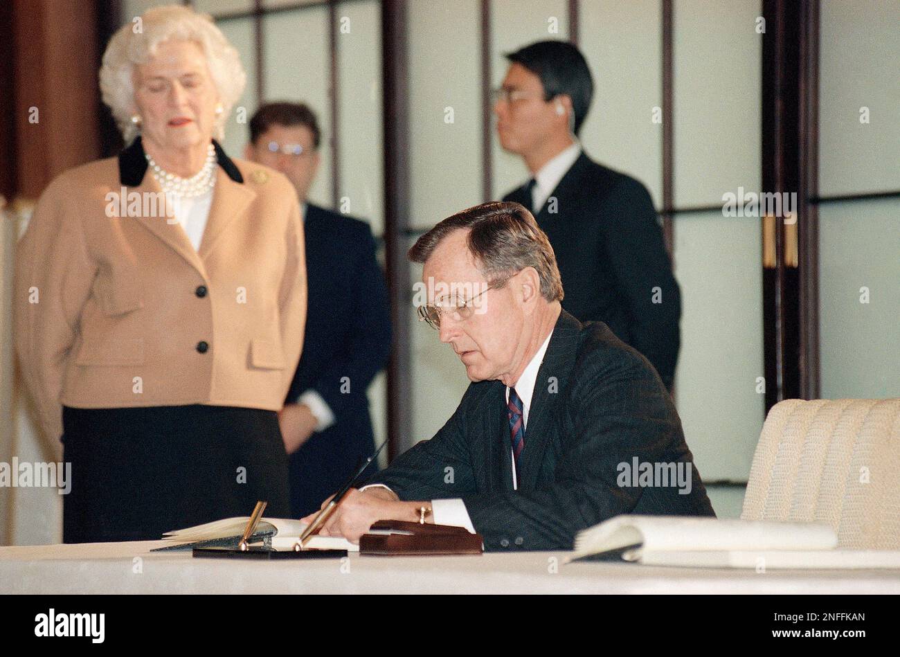 U.S. President-elect George Bush signs a condolence book for the late ...