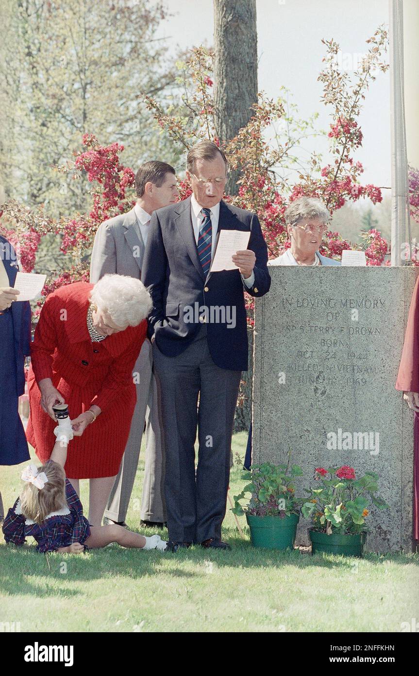 Marshall Bush, 3, gets some assistance with her shoe from her ...