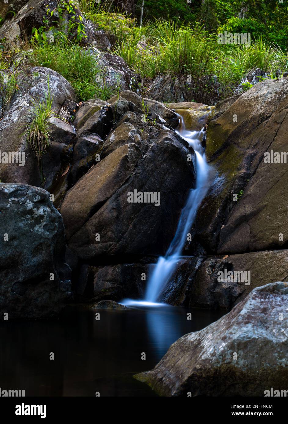 A body of water cascading over a large rocky riverbed, creating a ...