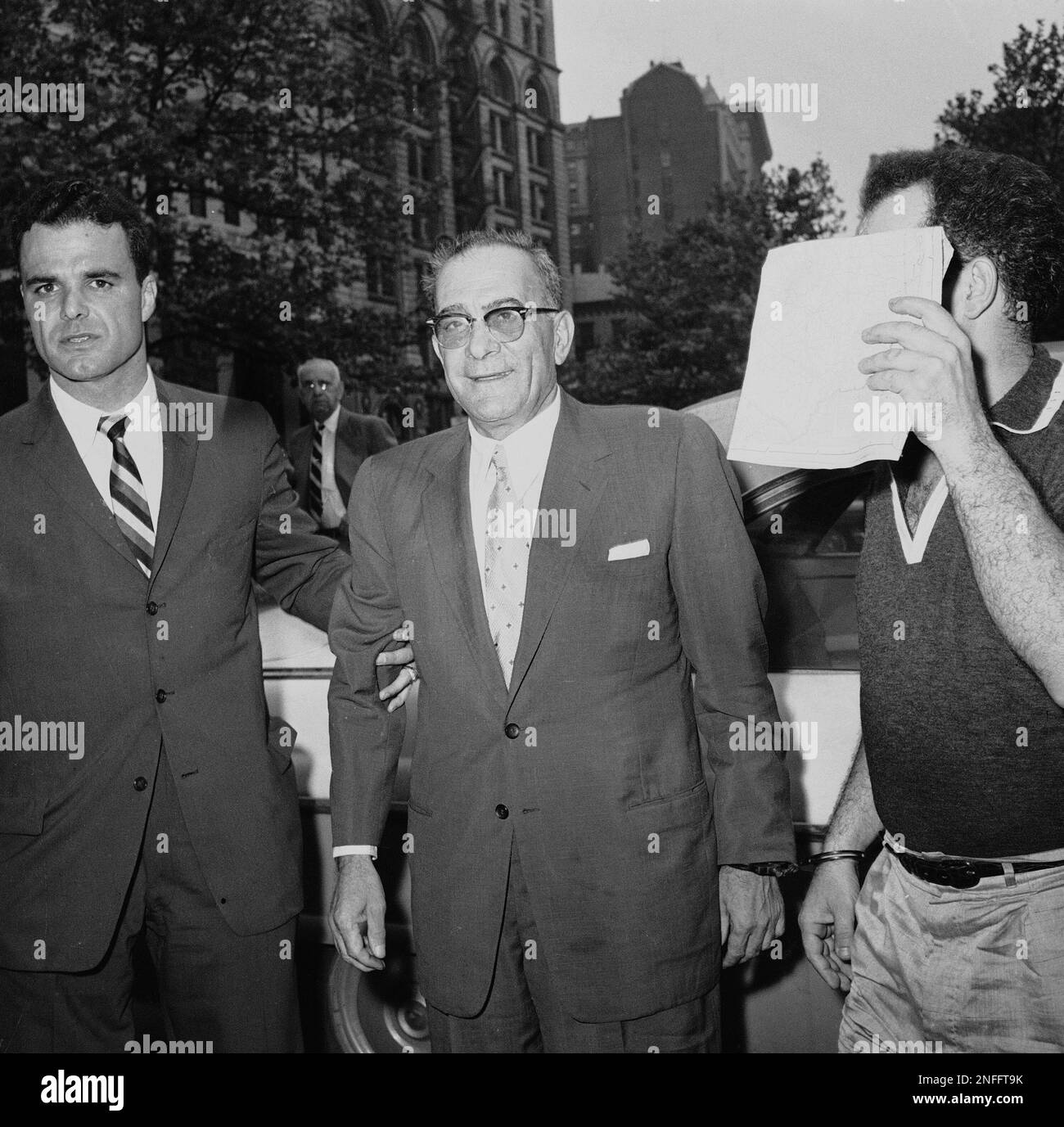 Vito Genovese, left, reputed mobster, is handcuffed to an unidentied ...