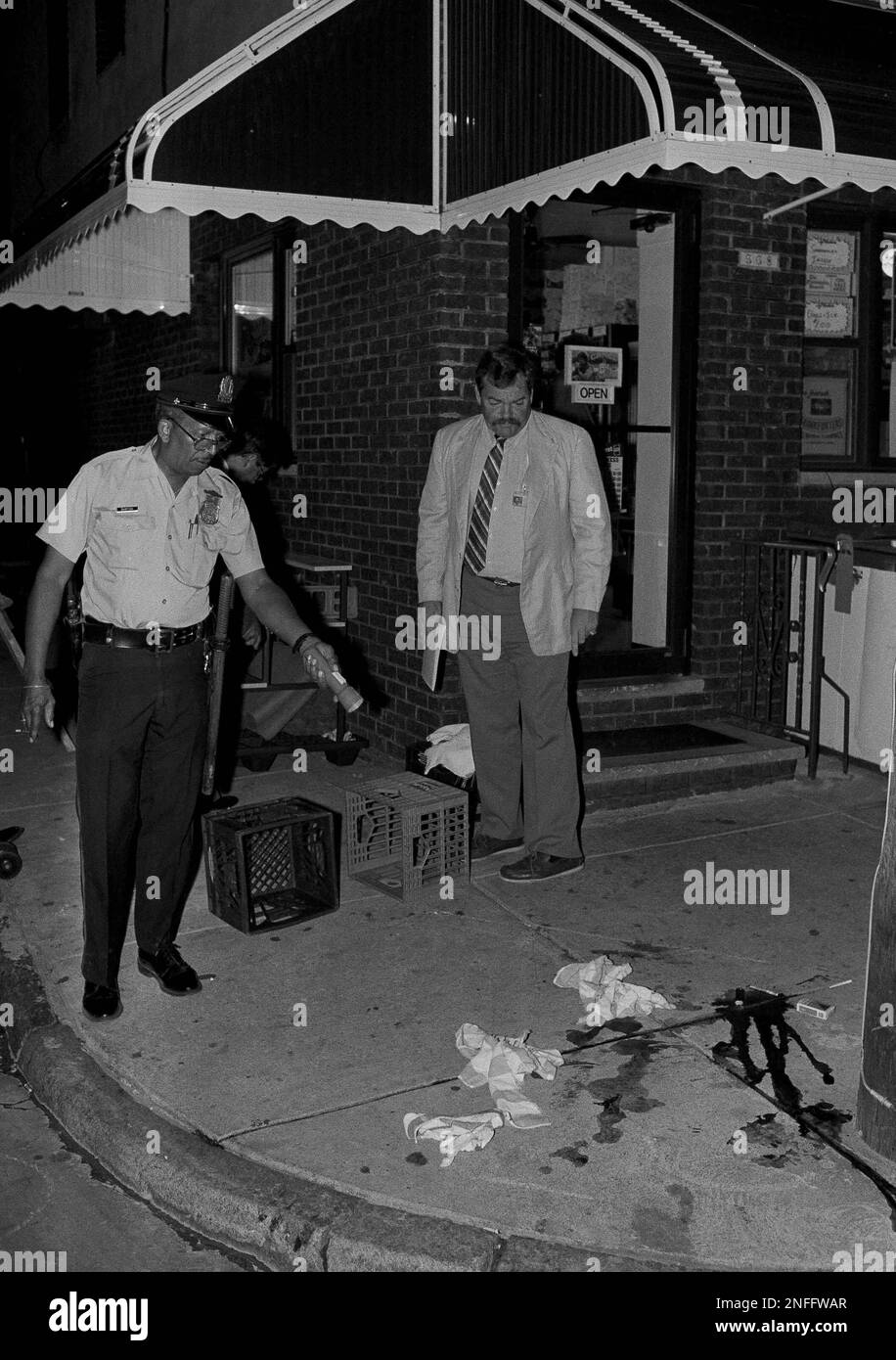 Philadelphia police and detectives examine the scene where reputed ...