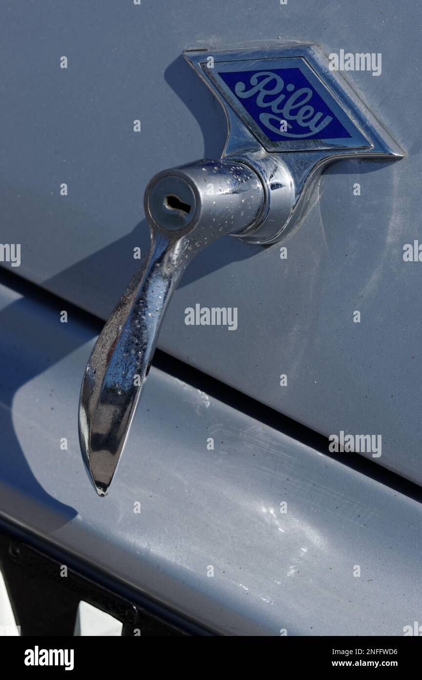 Locking boot lid handle of a grey classic Riley car, showing some ...