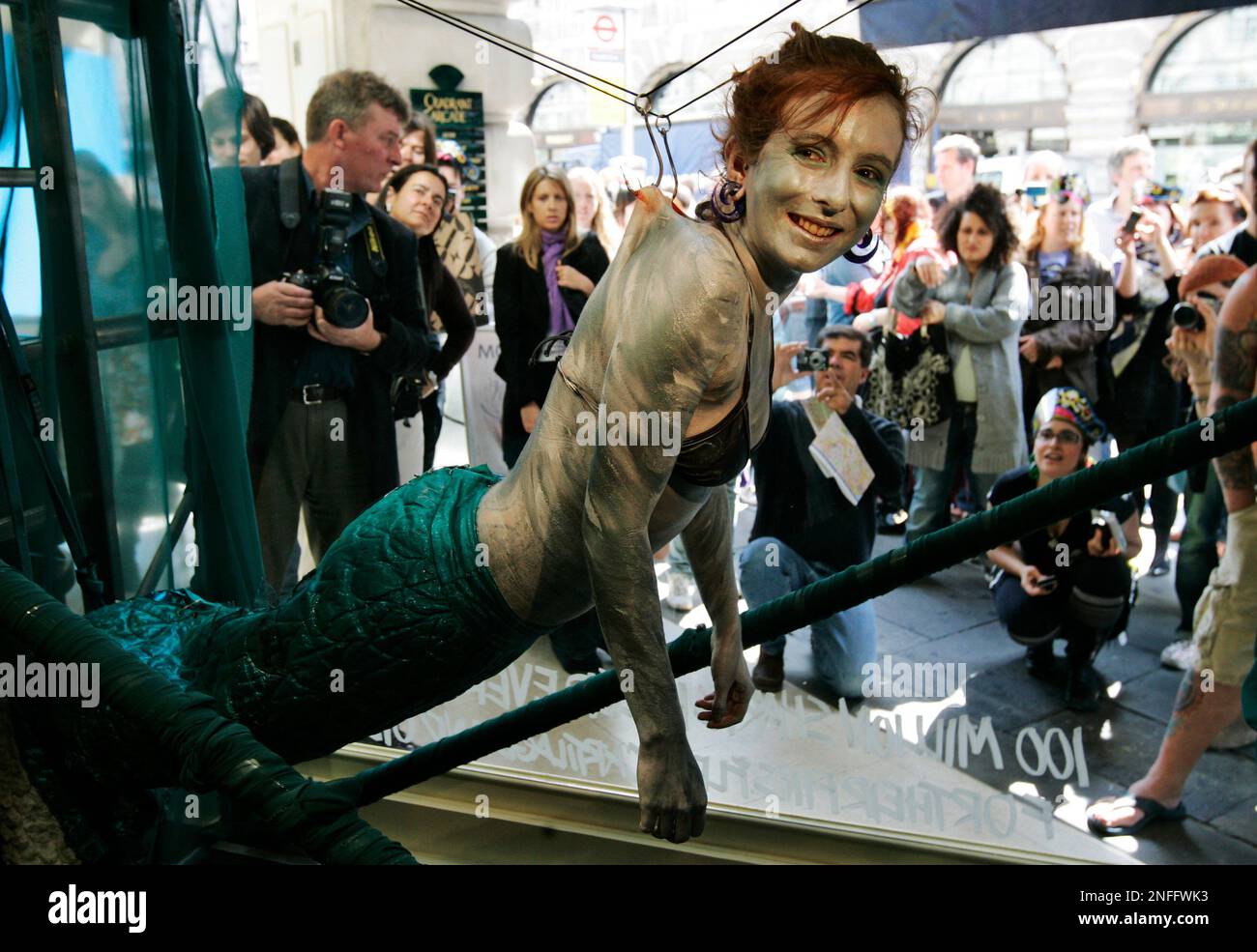 Performance artist Alice Newstead, is seen with her skin pierced with ...