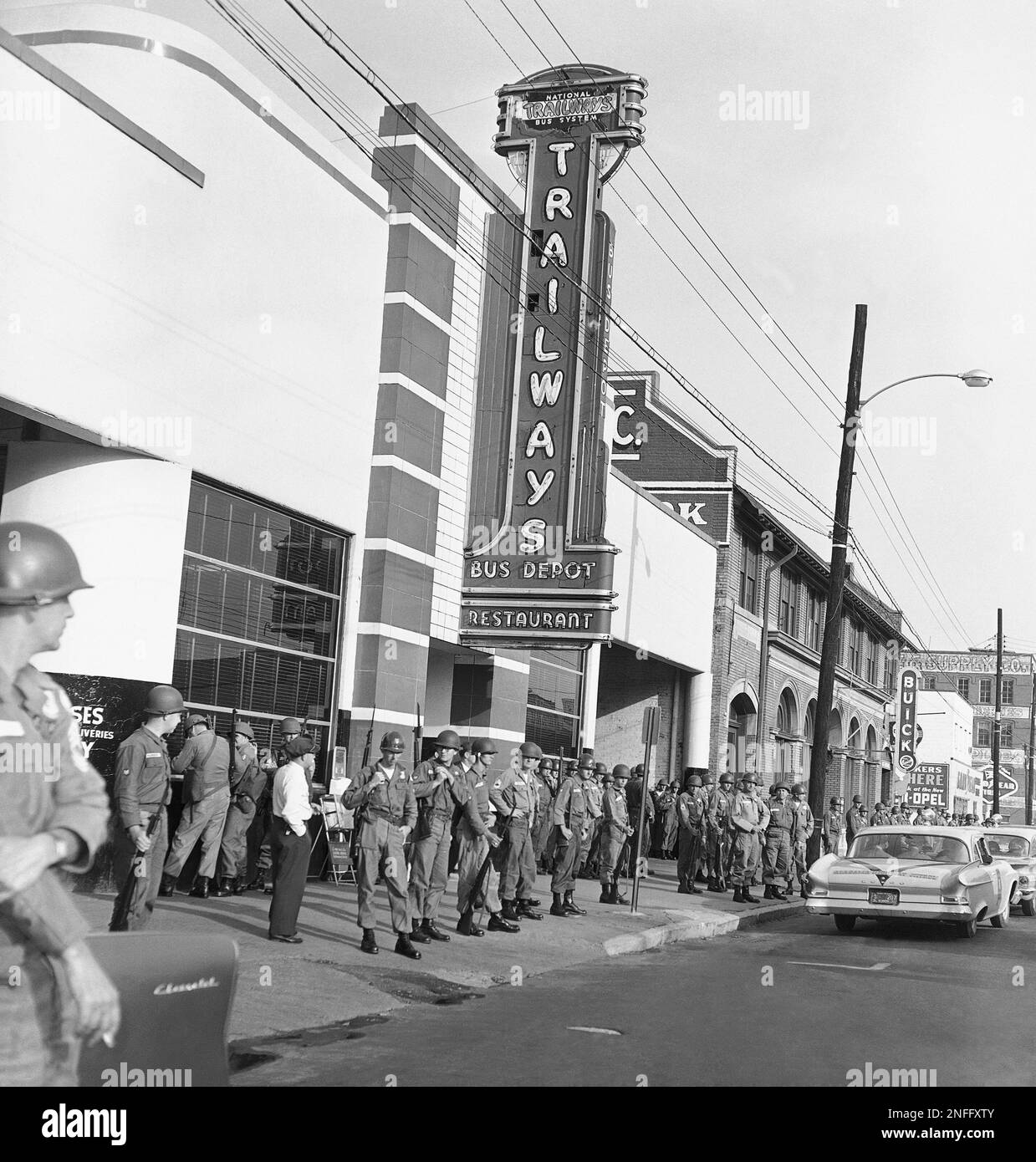Troops of National Guardsmen stand on duty at the Trailways bus station ...