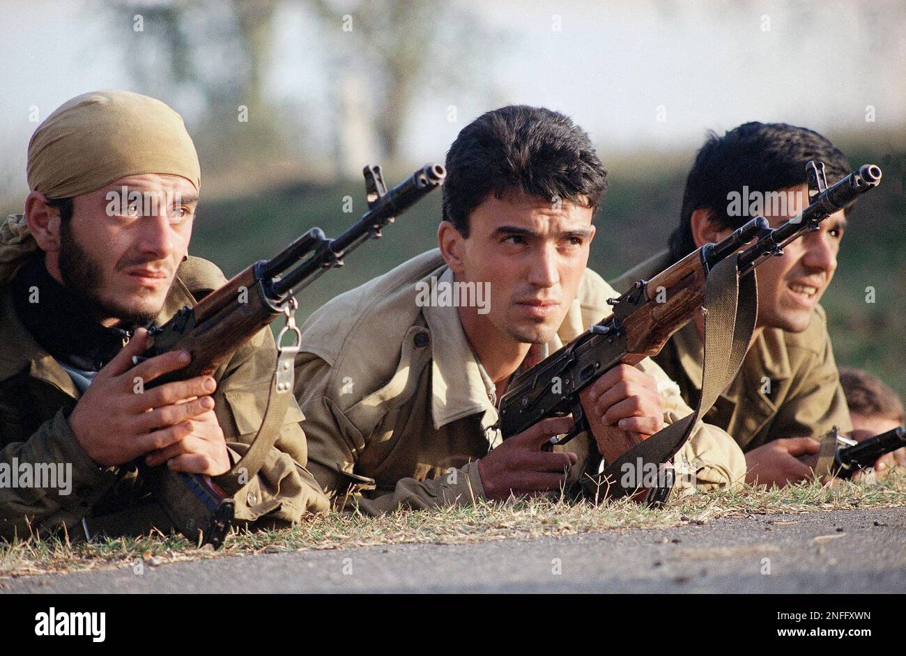 Three Georgian government soldiers look over enemy positions in the ...
