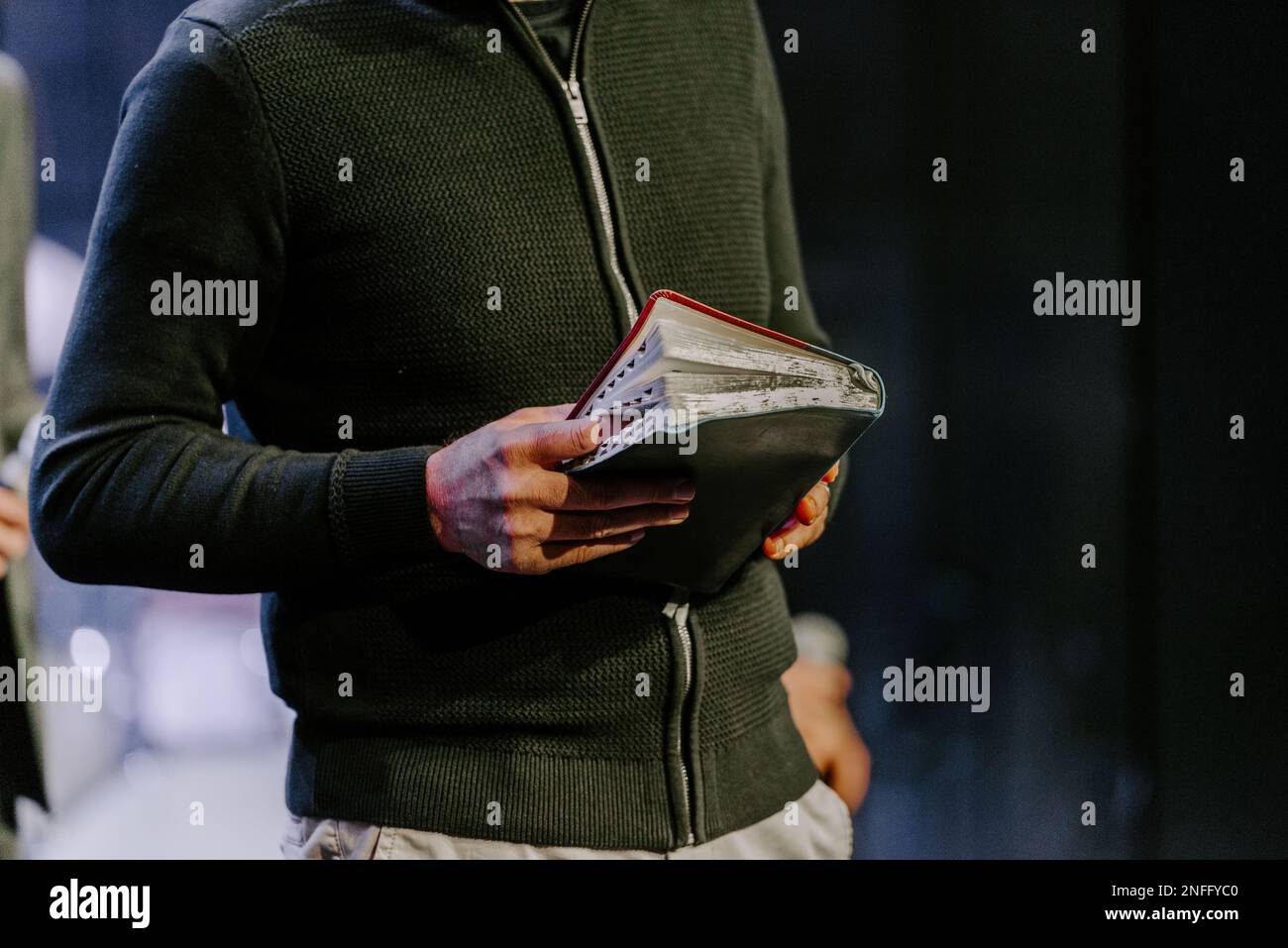 Pastor with a Bible in his hand during a sermon. The preacher delivers ...