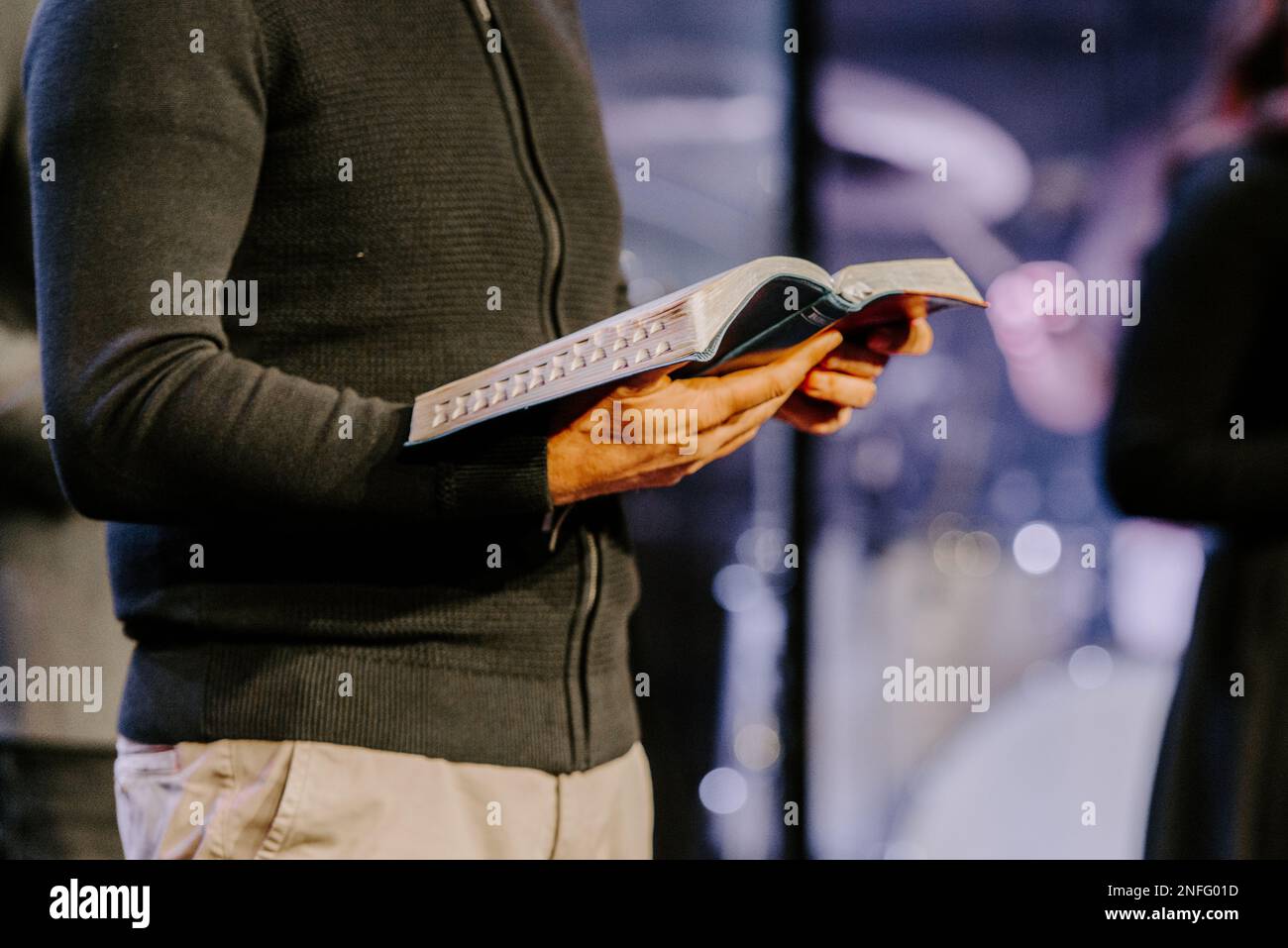 Pastor with a Bible in his hand during a sermon. The preacher delivers ...