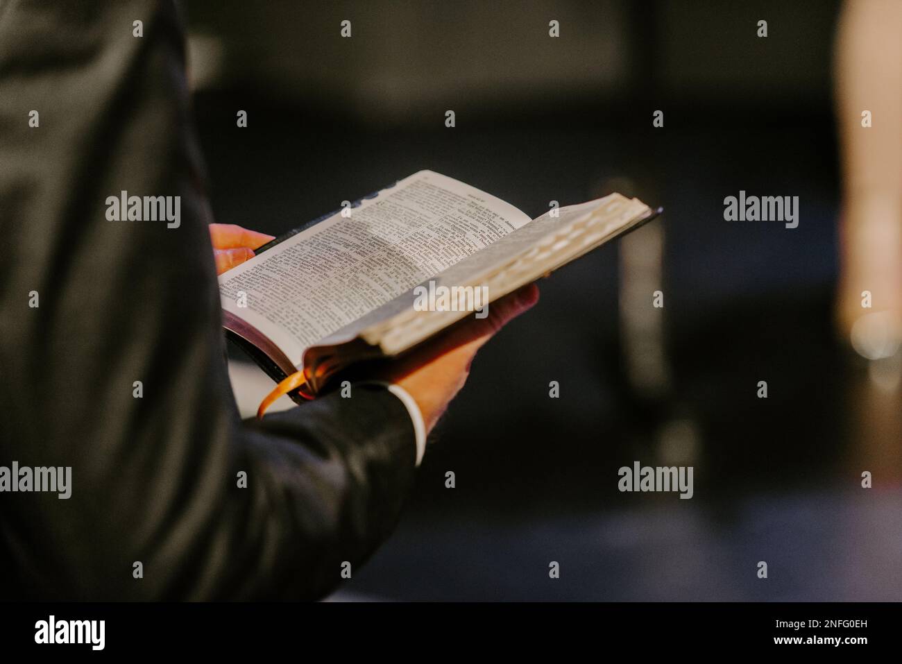 Pastor with a Bible in his hand during a sermon. The preacher delivers ...