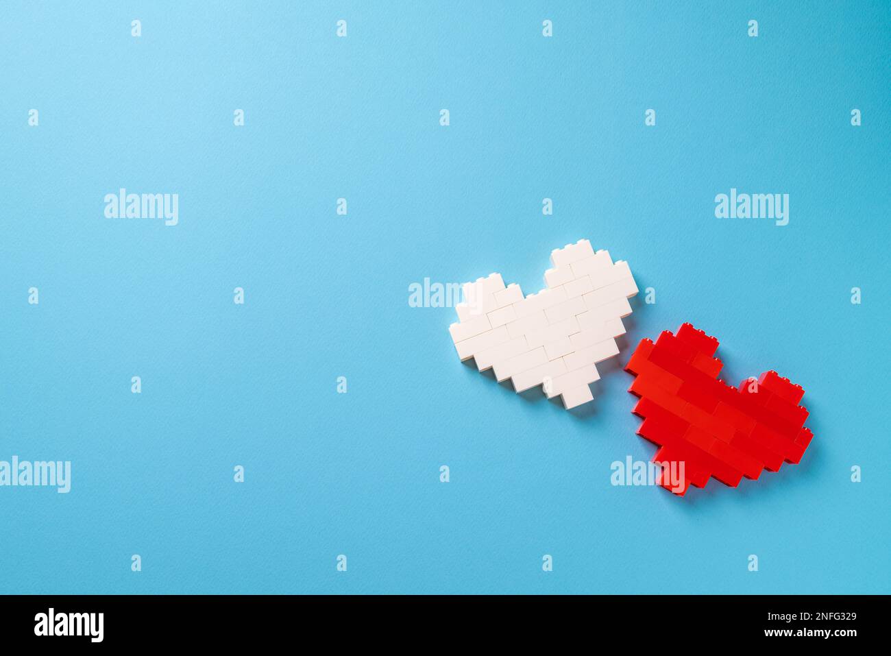 Red and white heart made of plastic bricks on a blue background Stock ...