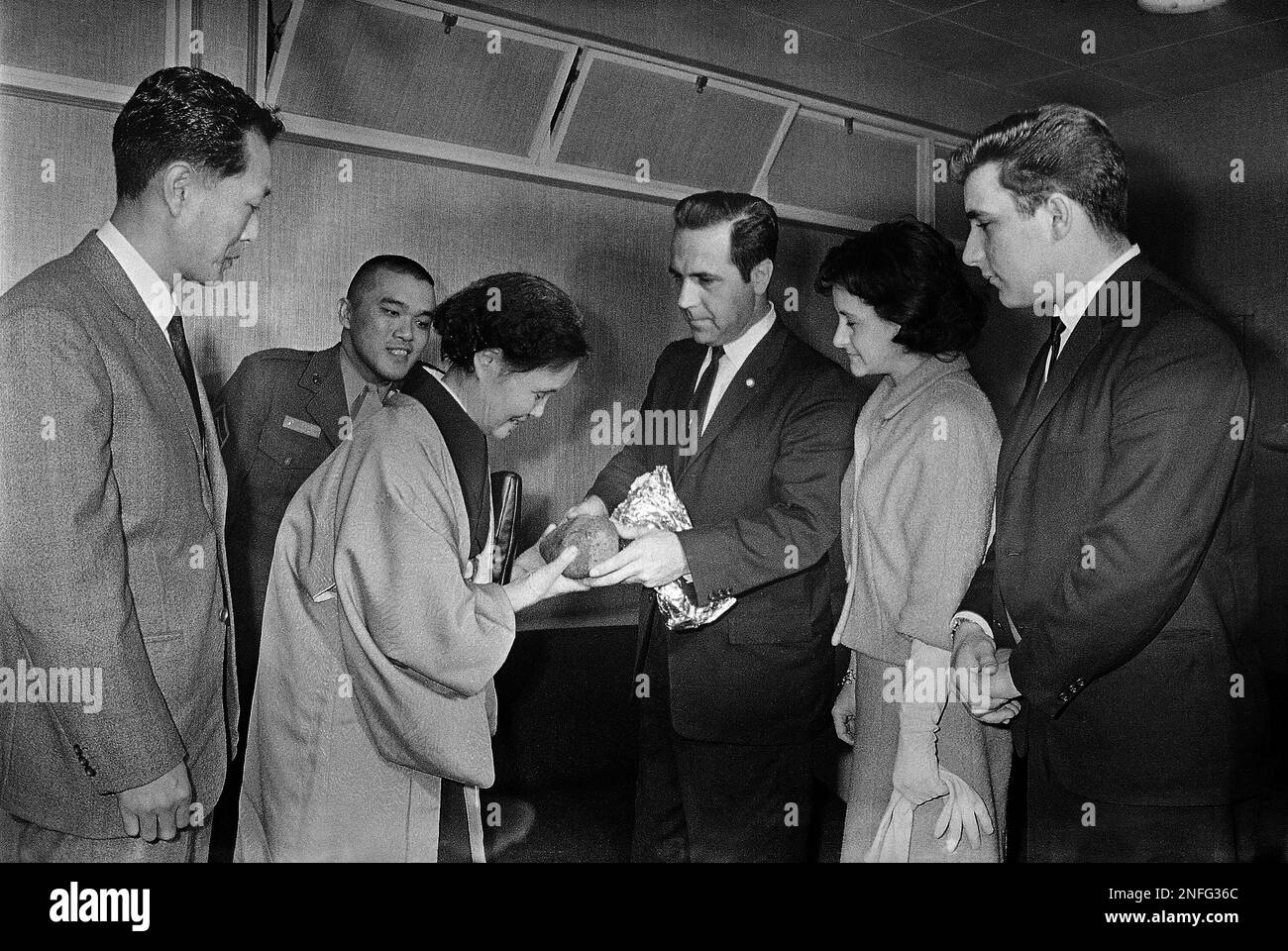 Rene Gagnon hands a stone from Mt. Suribachi on Iwo Jima to widow of ...