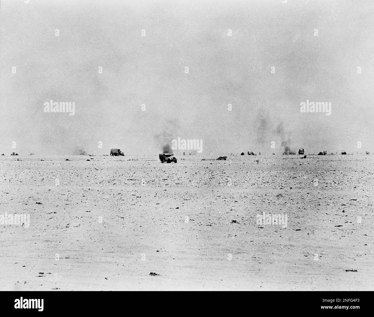 Axis artillery shells burst among British vehicles and forward ...