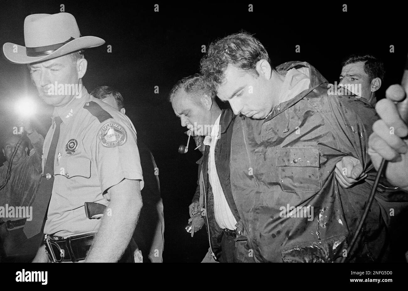 Kidnapping suspect Gary Steven Krist, his hands handcuffed behind him ...