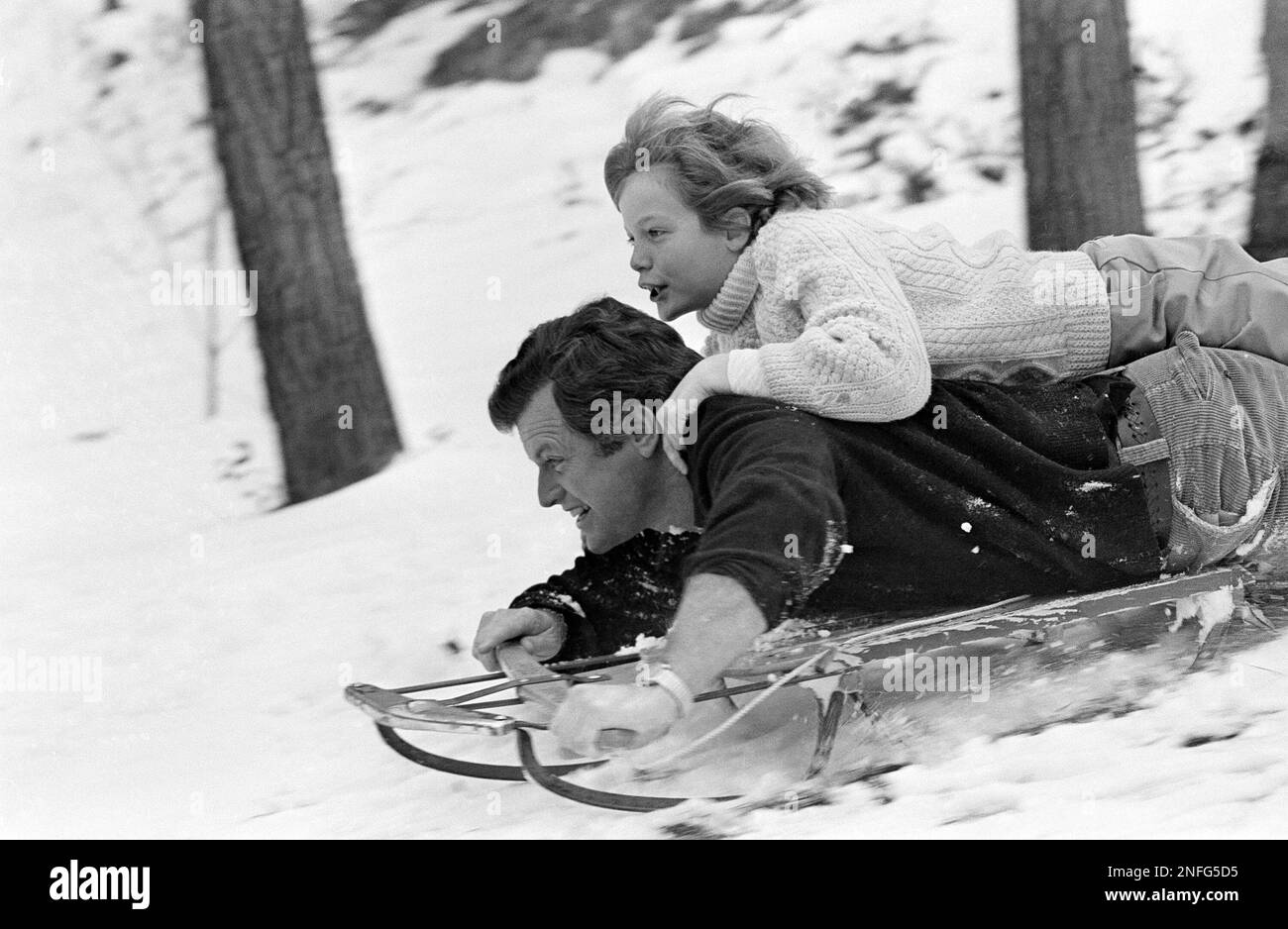 Edward Kennedy Jr., rides down a snow covered hill with his father, Sen ...