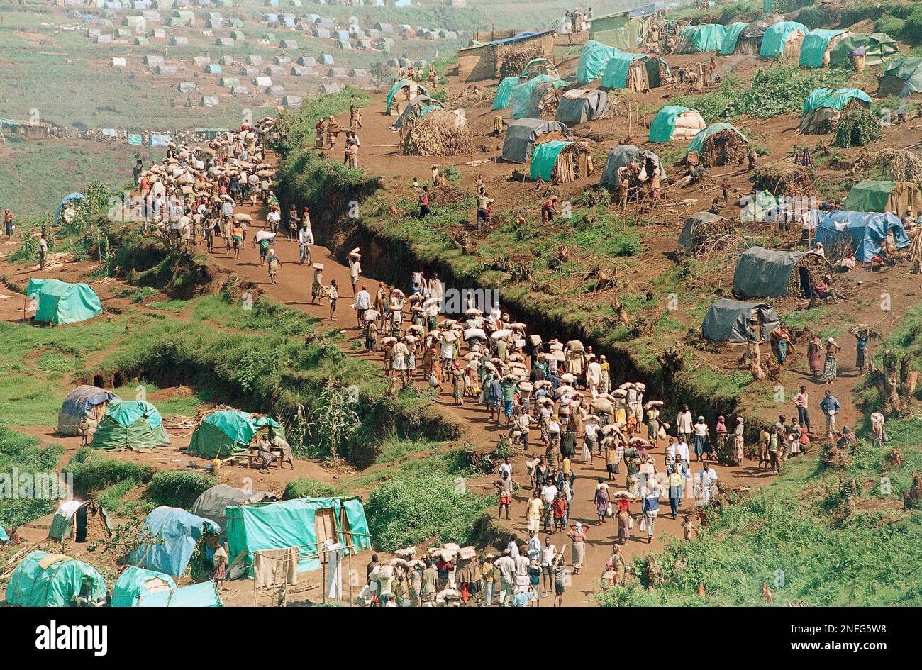 Rwandans in the Kibeho refugee camp in southwestern Rwanda go about ...