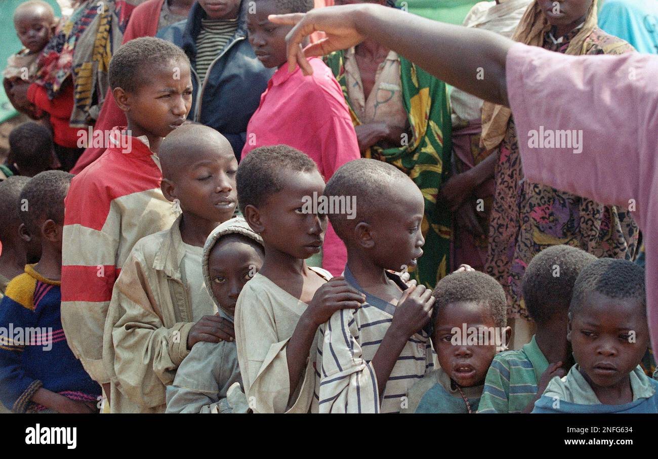 Refugee children line up for medical treatment at a field hospital run ...